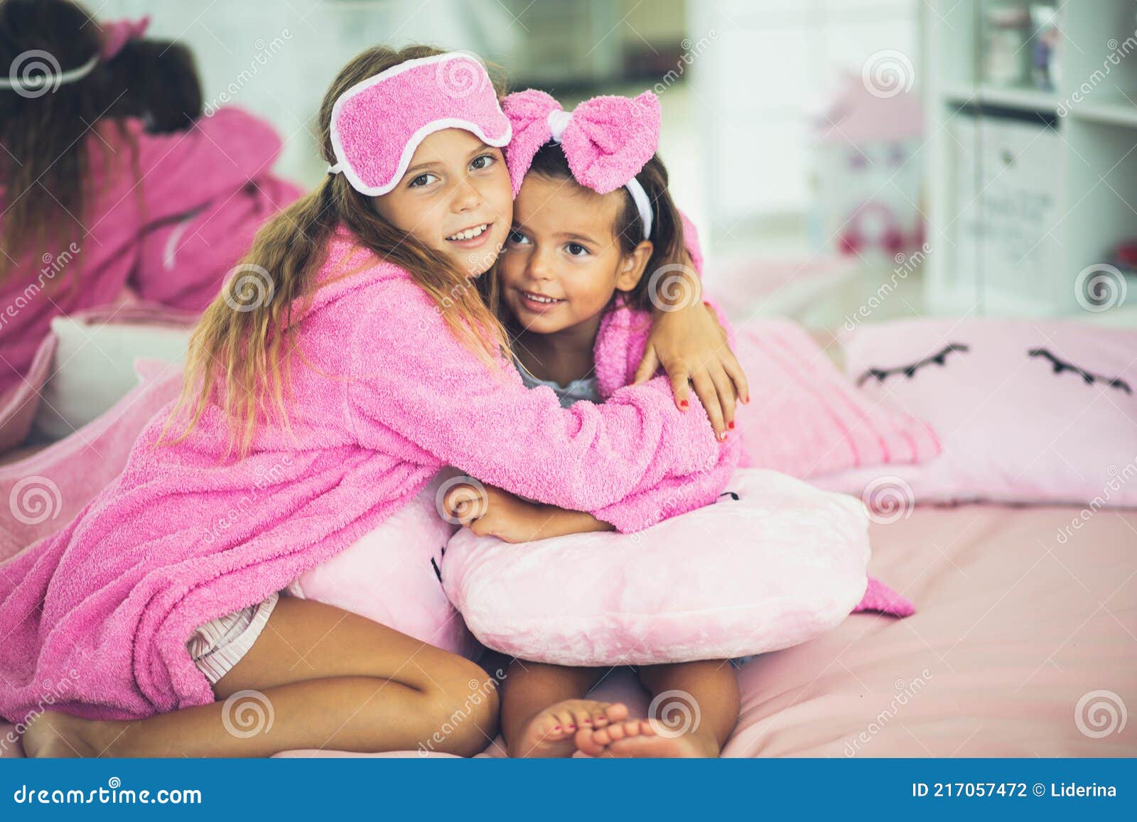 Two Little Girls on Bed in Hug Stock Photo - Image of caucasian ...