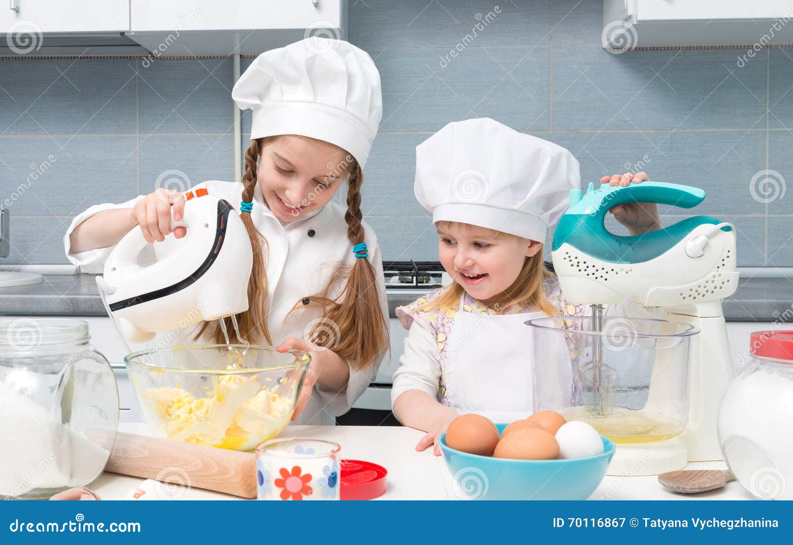 Two Little Girls in Chef Uniform with Ingredients on Table Stock Image ...