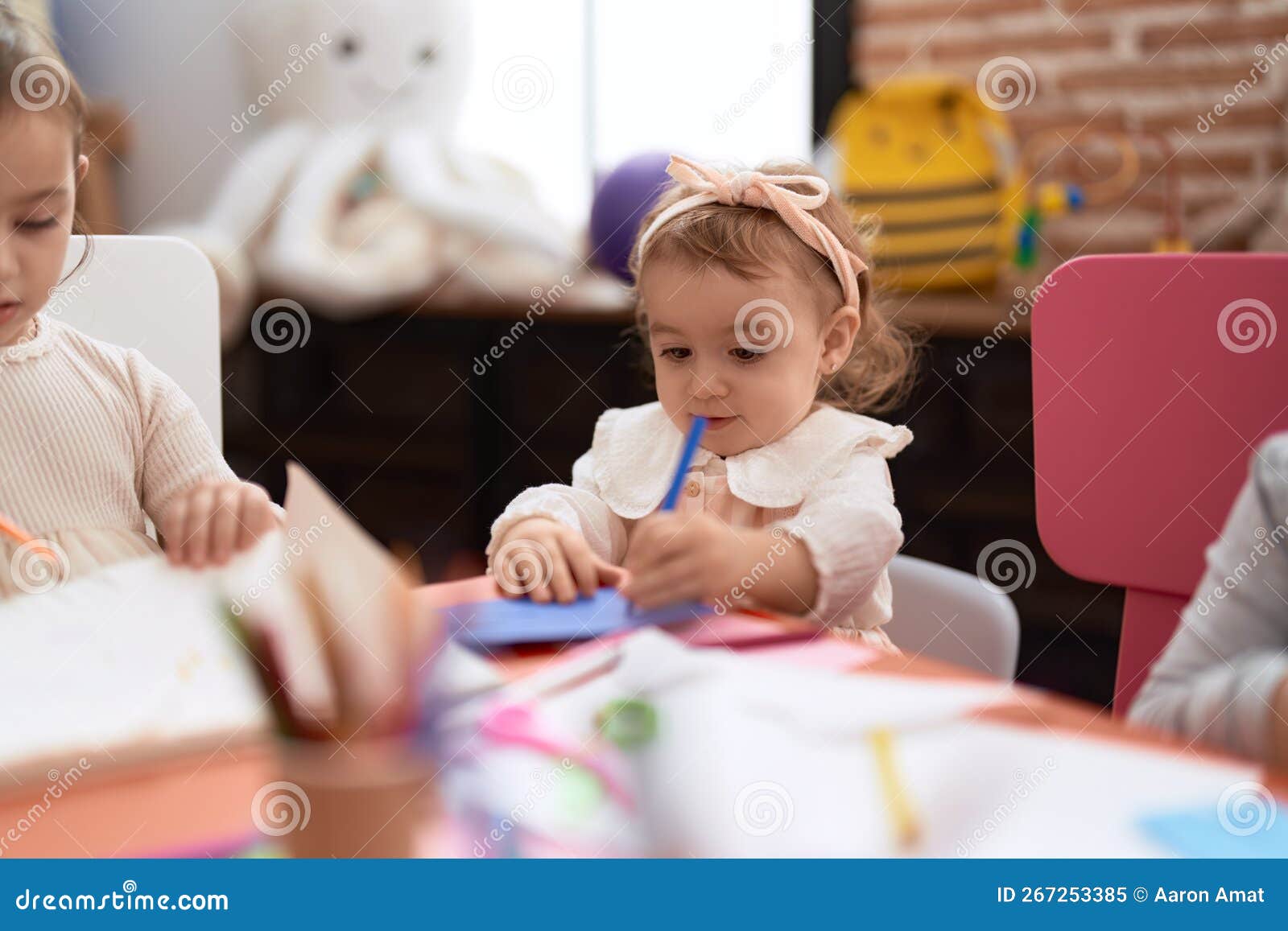 Two Little Girls Drawing on Notebook Sitting on Table at Kindergarten ...