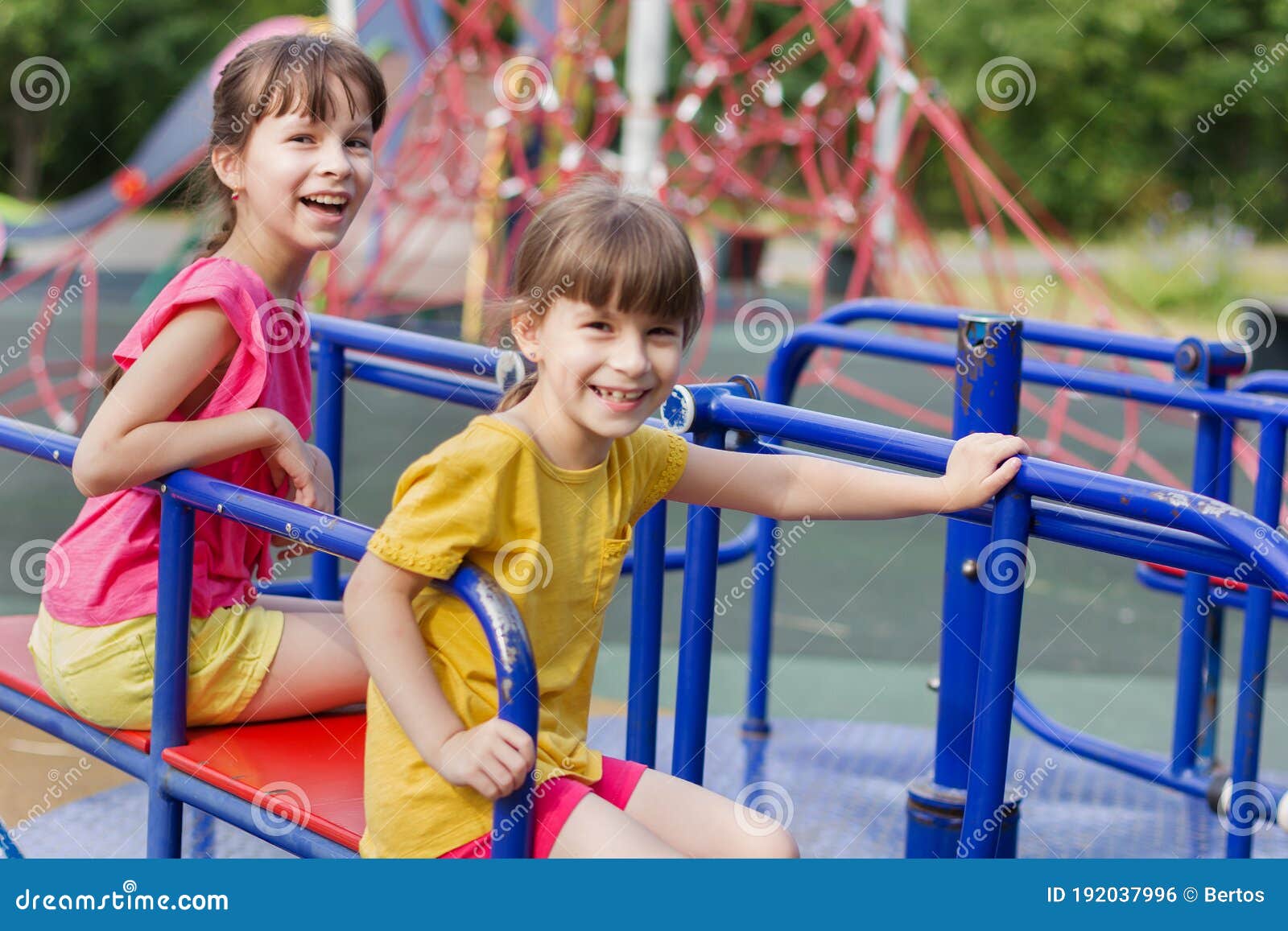 Two Little Girls Laughting on a Playground. Stock Photo - Image of ...