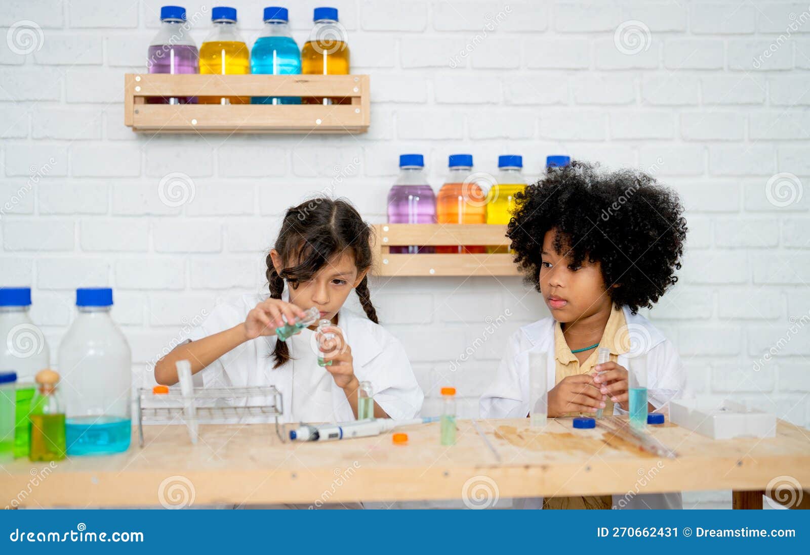 Two Little Girls Practice in Science Class with Different Laboratory ...