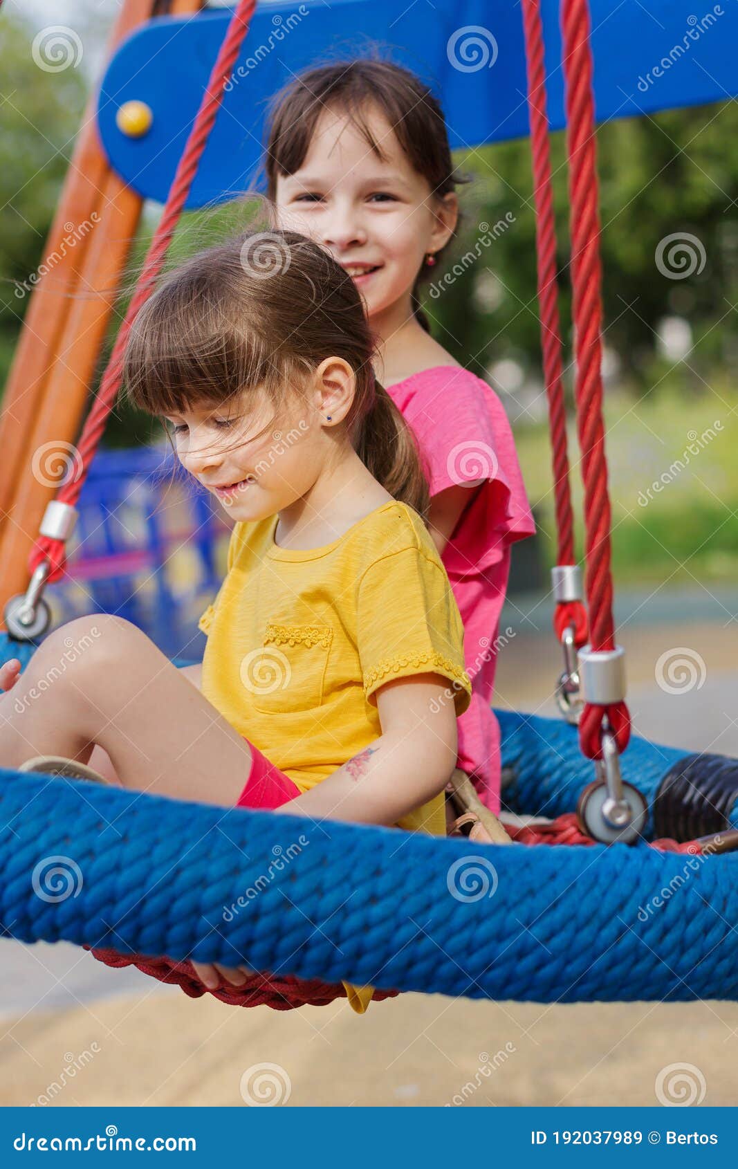 Two Little Girls on a Swing in the Park Stock Image - Image of female ...