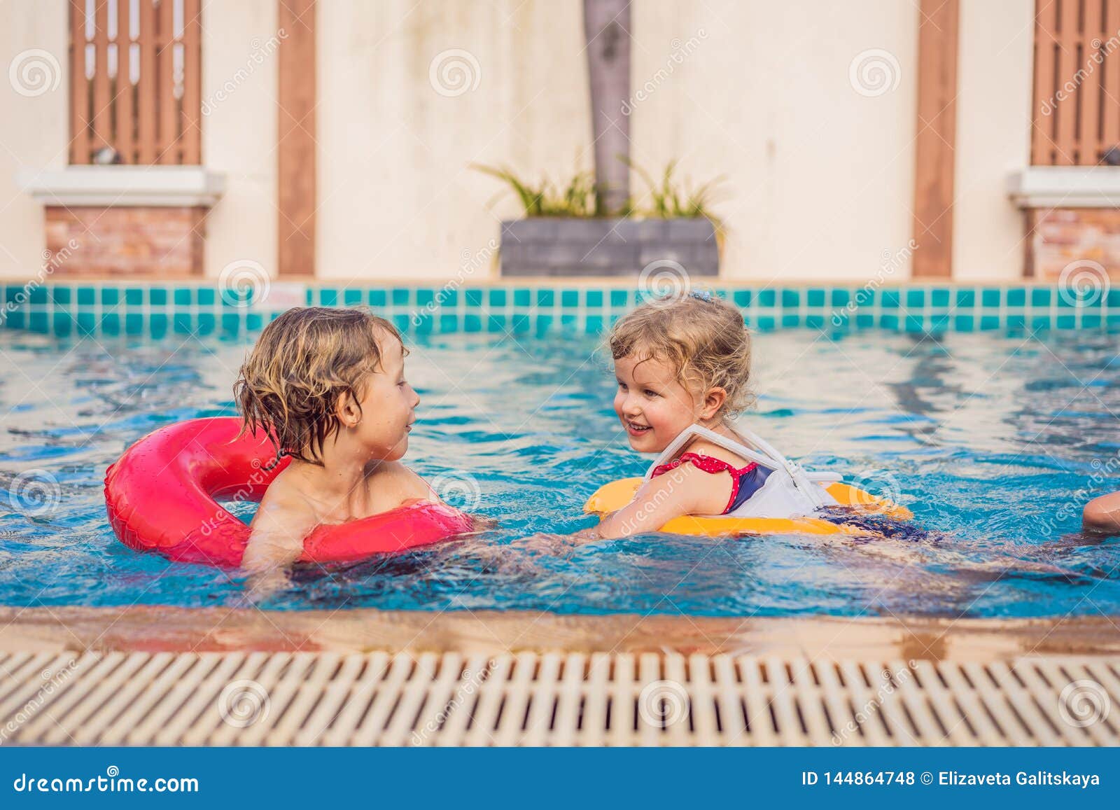 Two Little Kids Playing in the Swimming Pool Stock Photo - Image of ...