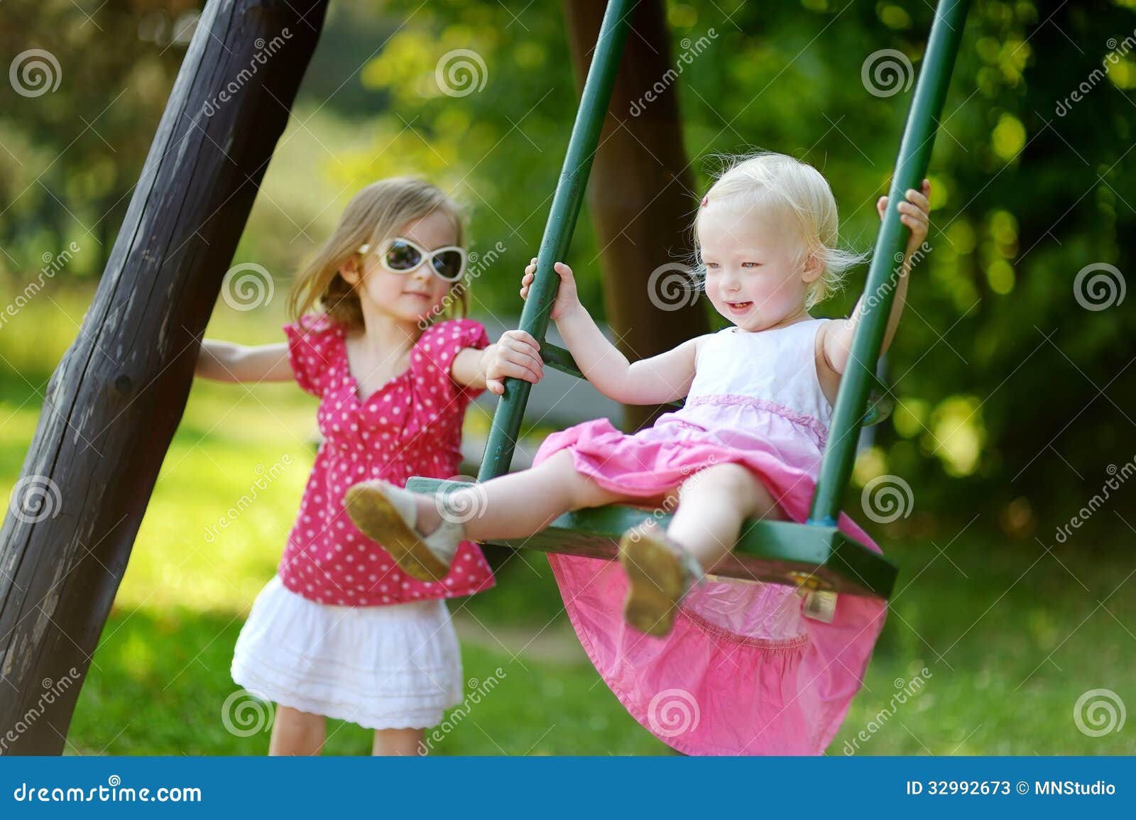Two Little Sisters Having Fun on a Swing Stock Image - Image of joyful ...