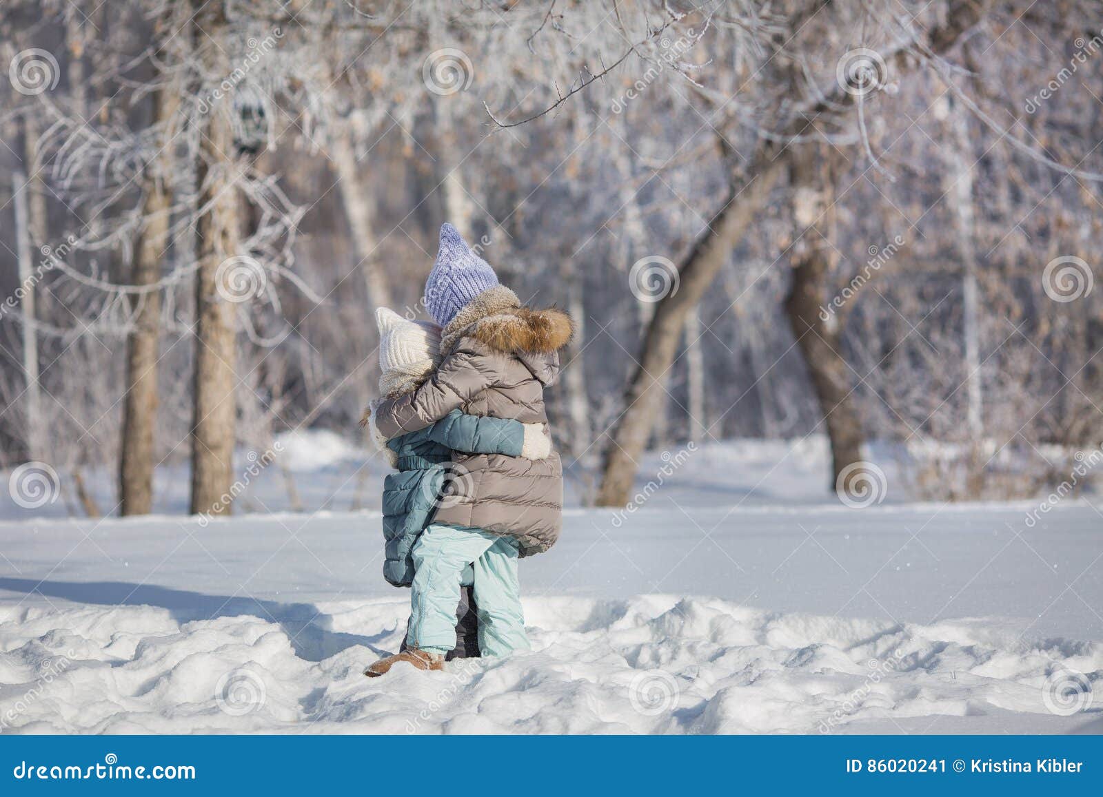 Two Little Sisters Hug Each Other in Snow in Winter Stock Image - Image ...
