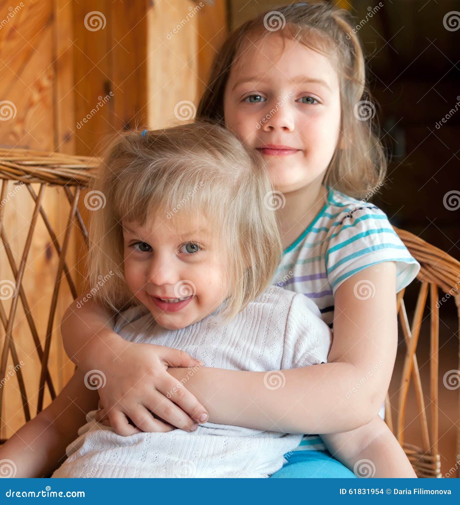 Two little sisters hugging stock photo. Image of girl - 61831954
