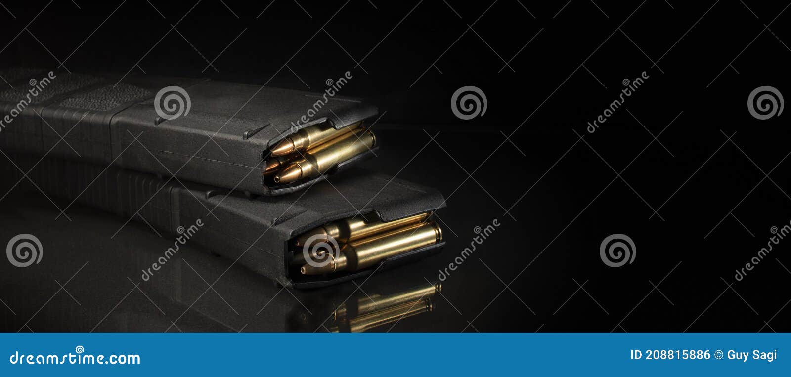 Two Loaded AR-15 Magazines on a Black Background with a Reflection and ...