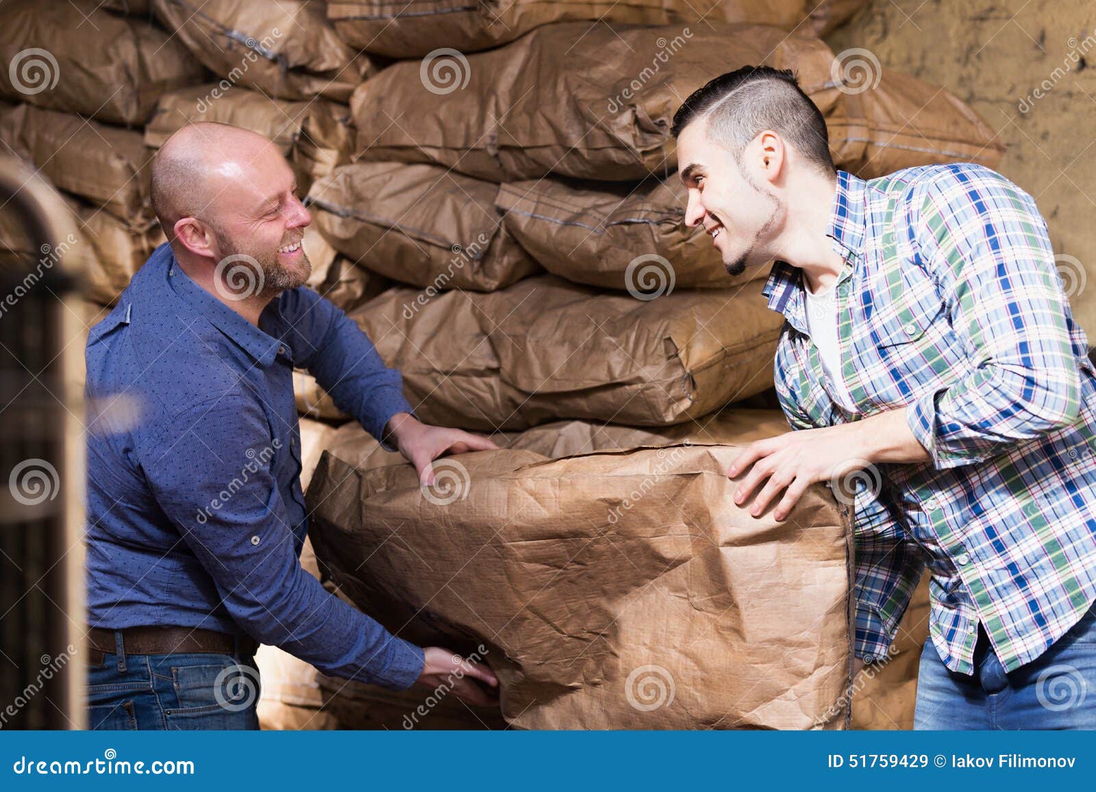 Two loaders handling sacks stock image. Image of grain - 51759429