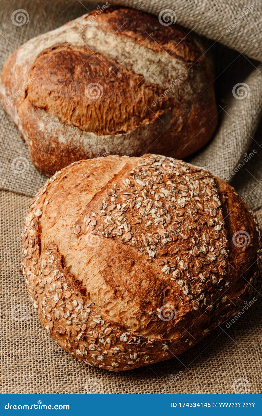 Two Loaves of Delicious Rustic Bread Lie on a Burlap-covered Surface ...
