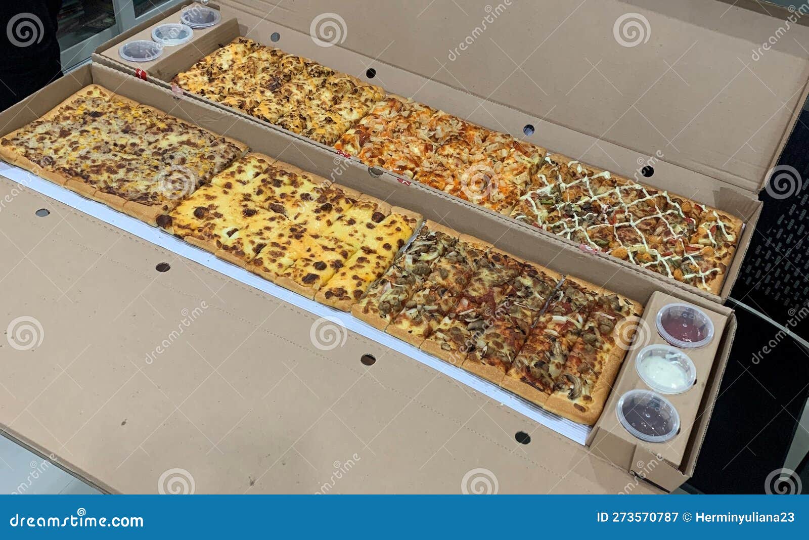 Two Long Pizzas with Different Flavors and 3 Different Types of Sauces ...