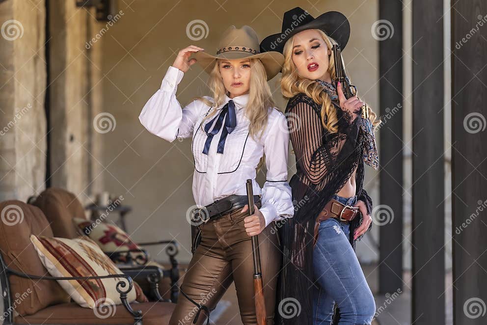Two Lovely Blonde Models Dressed As Cowgirls Enjoys The American West