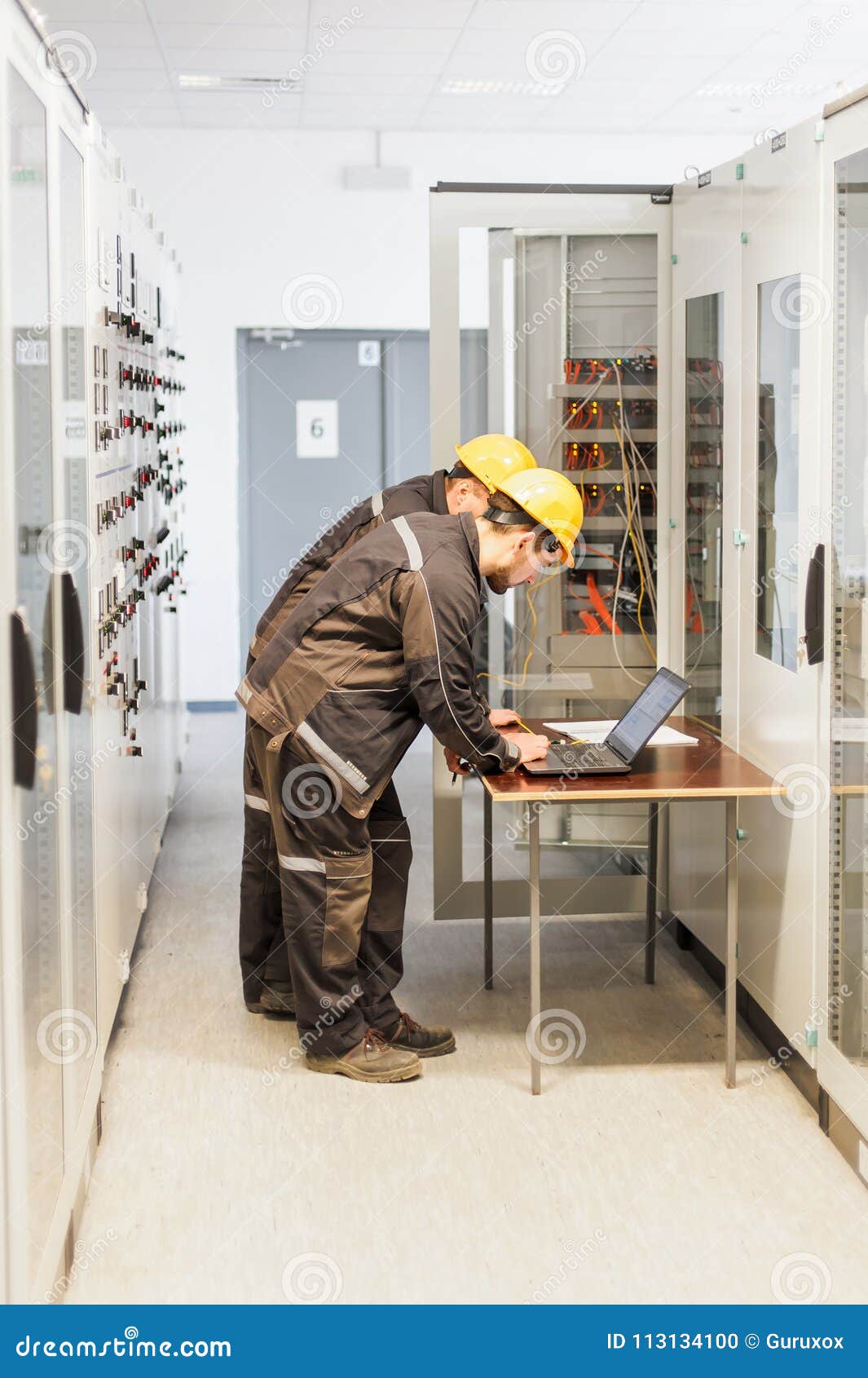 Two Maintenance Engineers Inspect Relay Protection System with L Stock ...