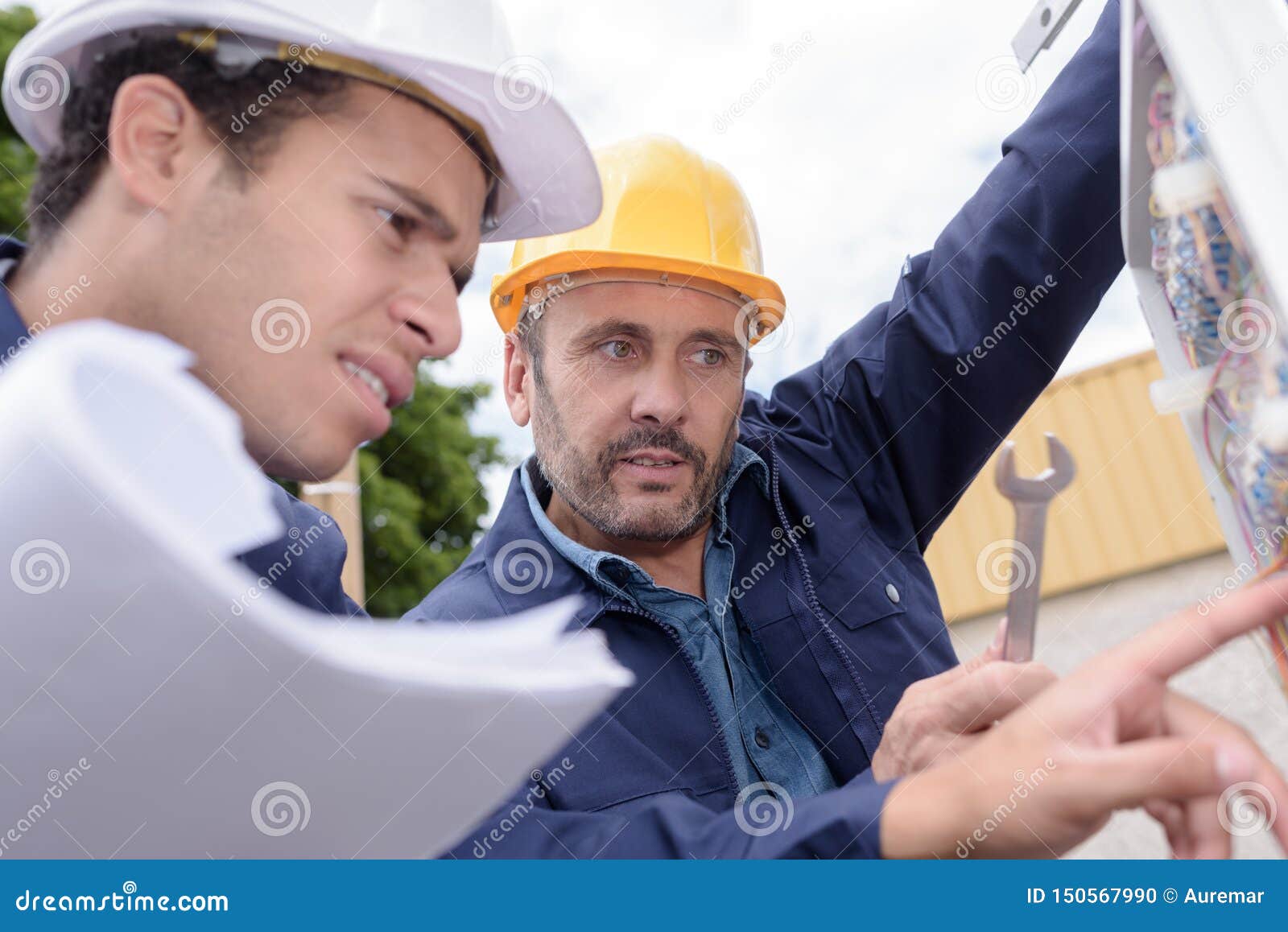Two Male Construction Workers Holding Roll Drawing and Tools Stock ...