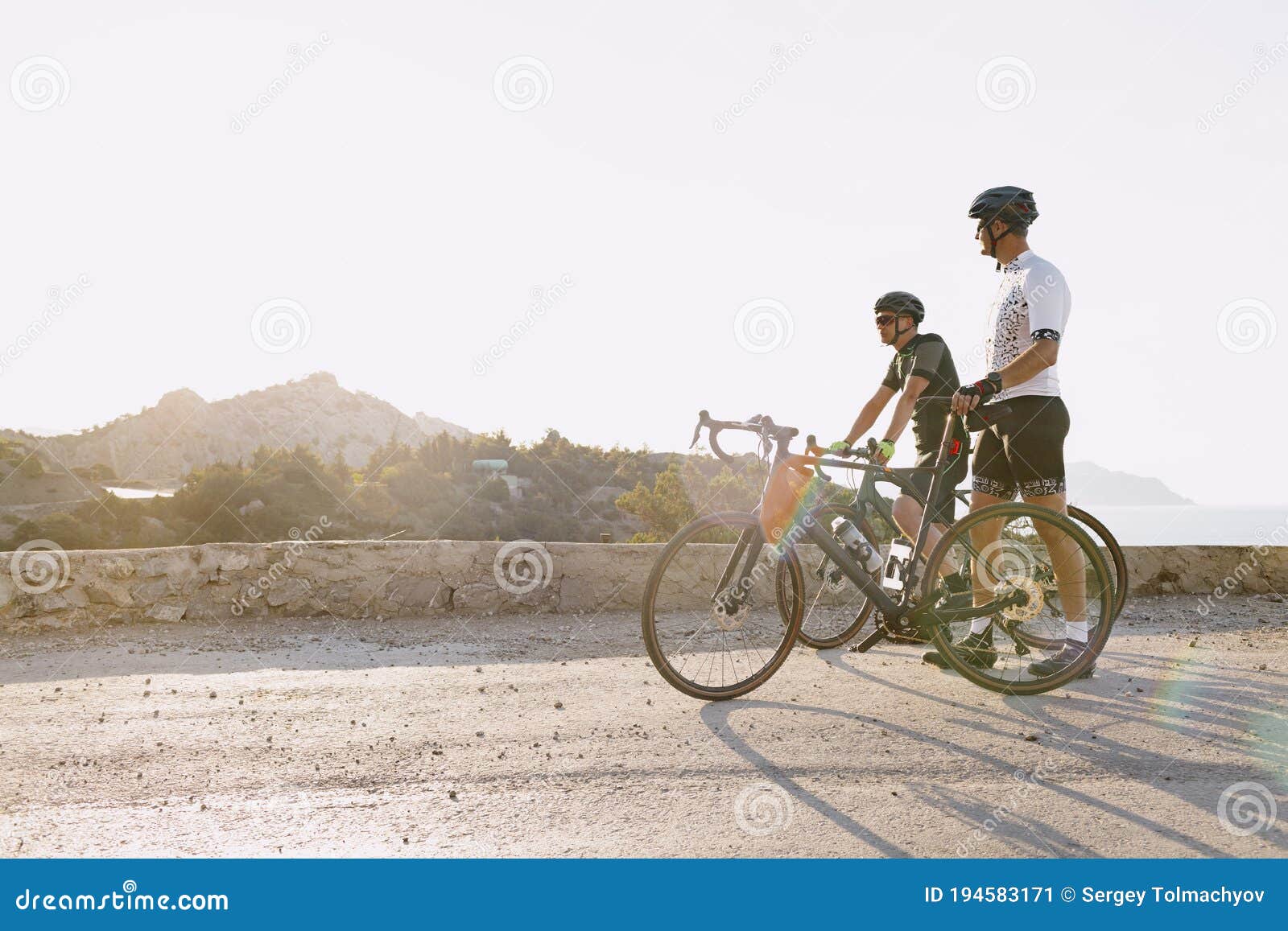 Two Male Cyclists Stand on the Road and Have a Rest Stock Image - Image ...