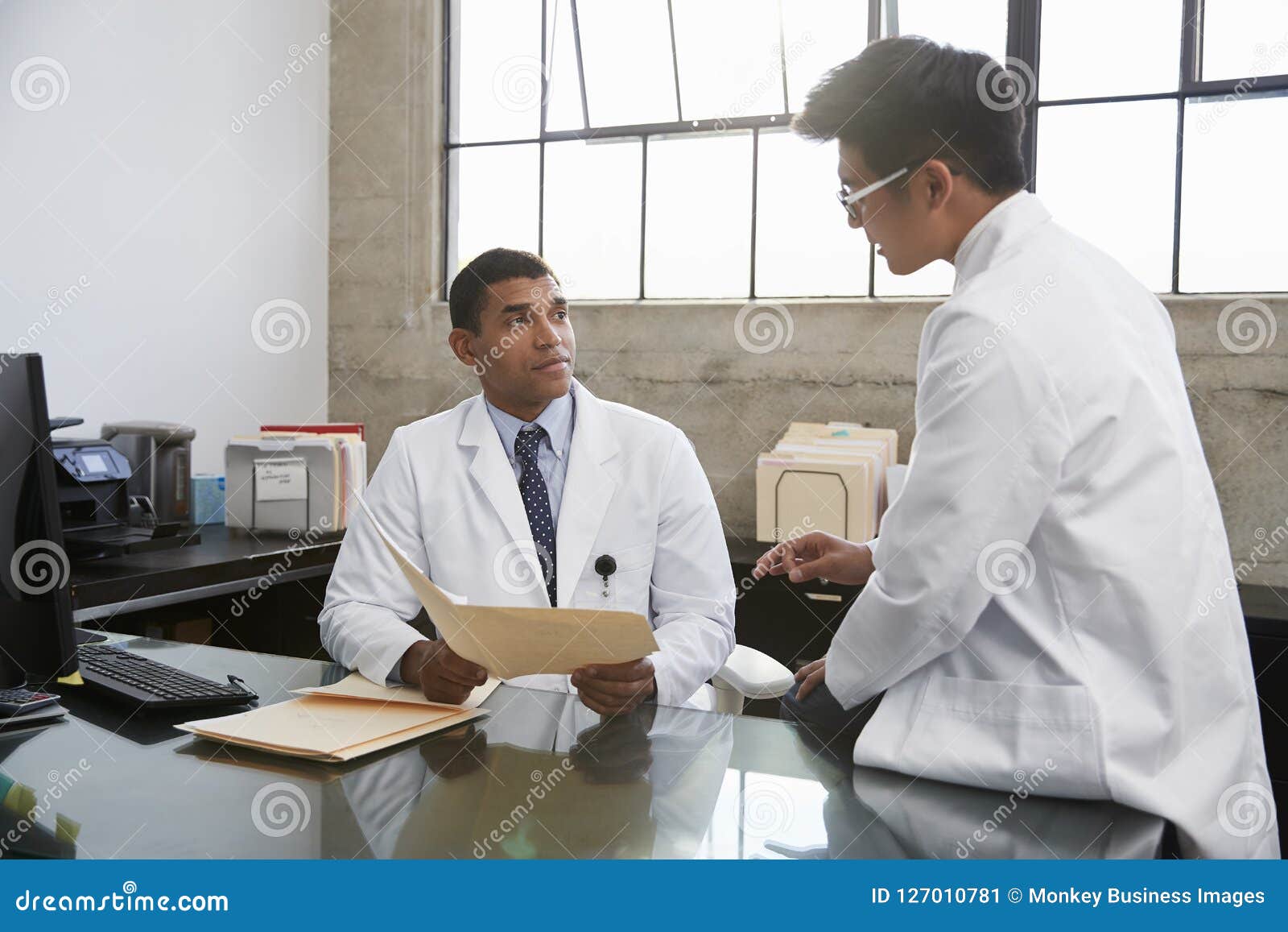 Two Male Doctors in Consultation at Desk in Office Stock Image - Image ...