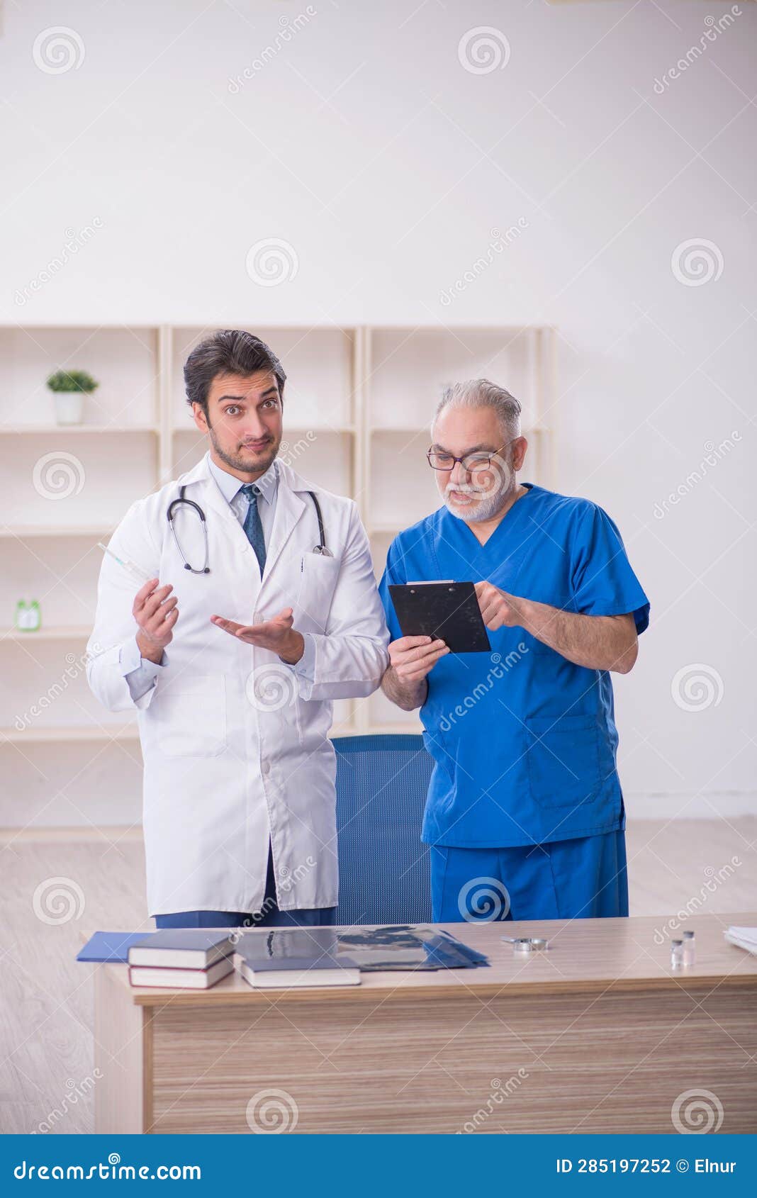 Two Male Doctors Working in the Clinic Stock Photo - Image of ...