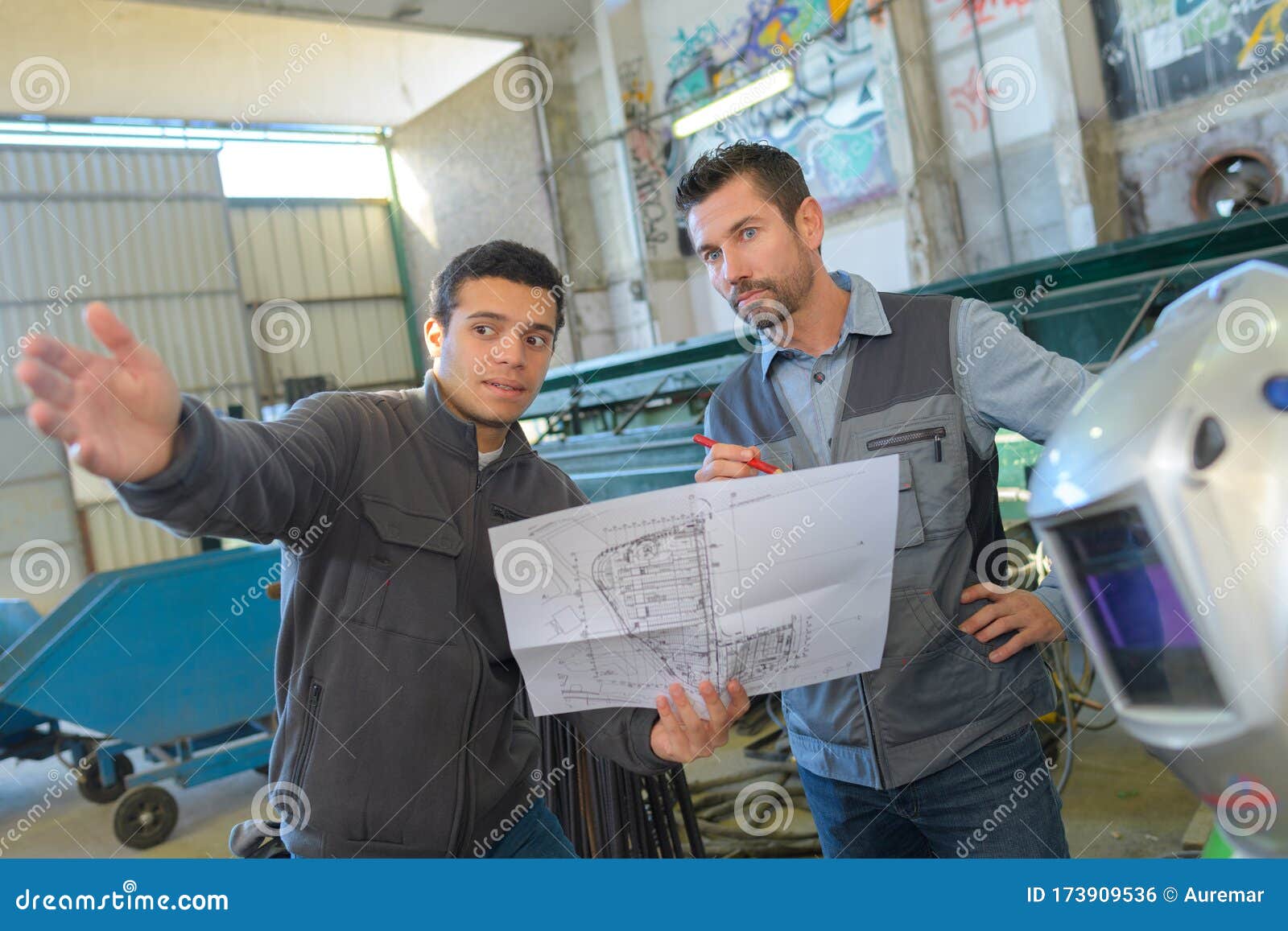 Two Male Engineers in Discussion while Holding Scale Drawings Stock ...