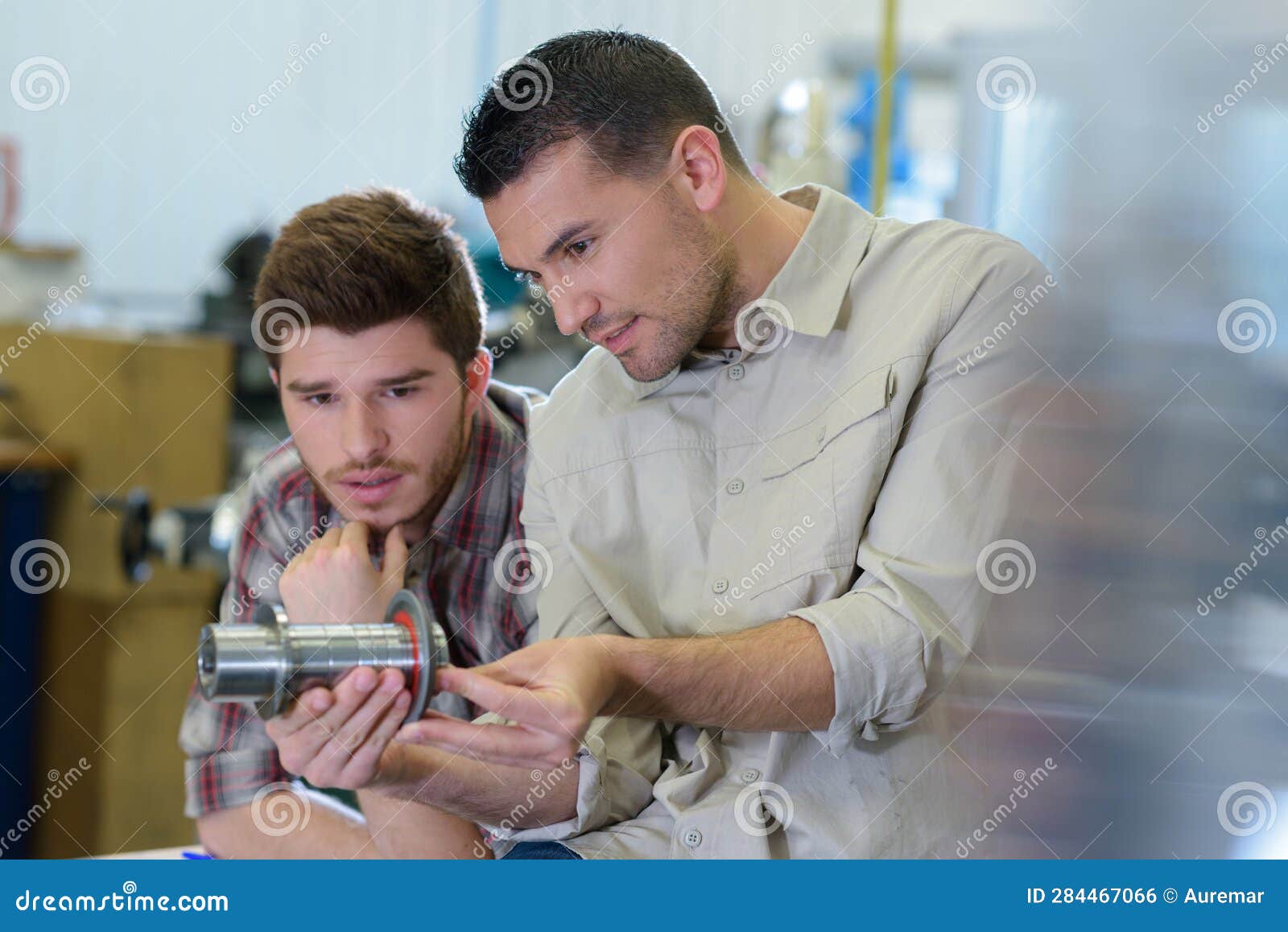 Two Male Engineers Examining Metal Shaft Stock Photo - Image of human ...