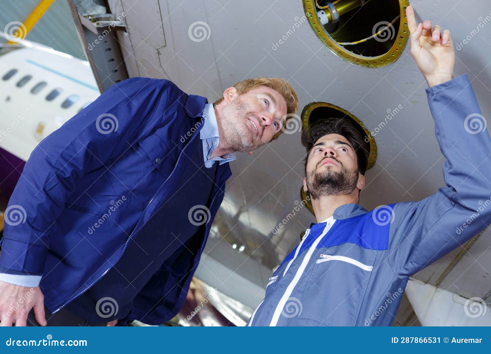 Two Male Engineers Inspecting Aircraft Stock Image - Image of control ...