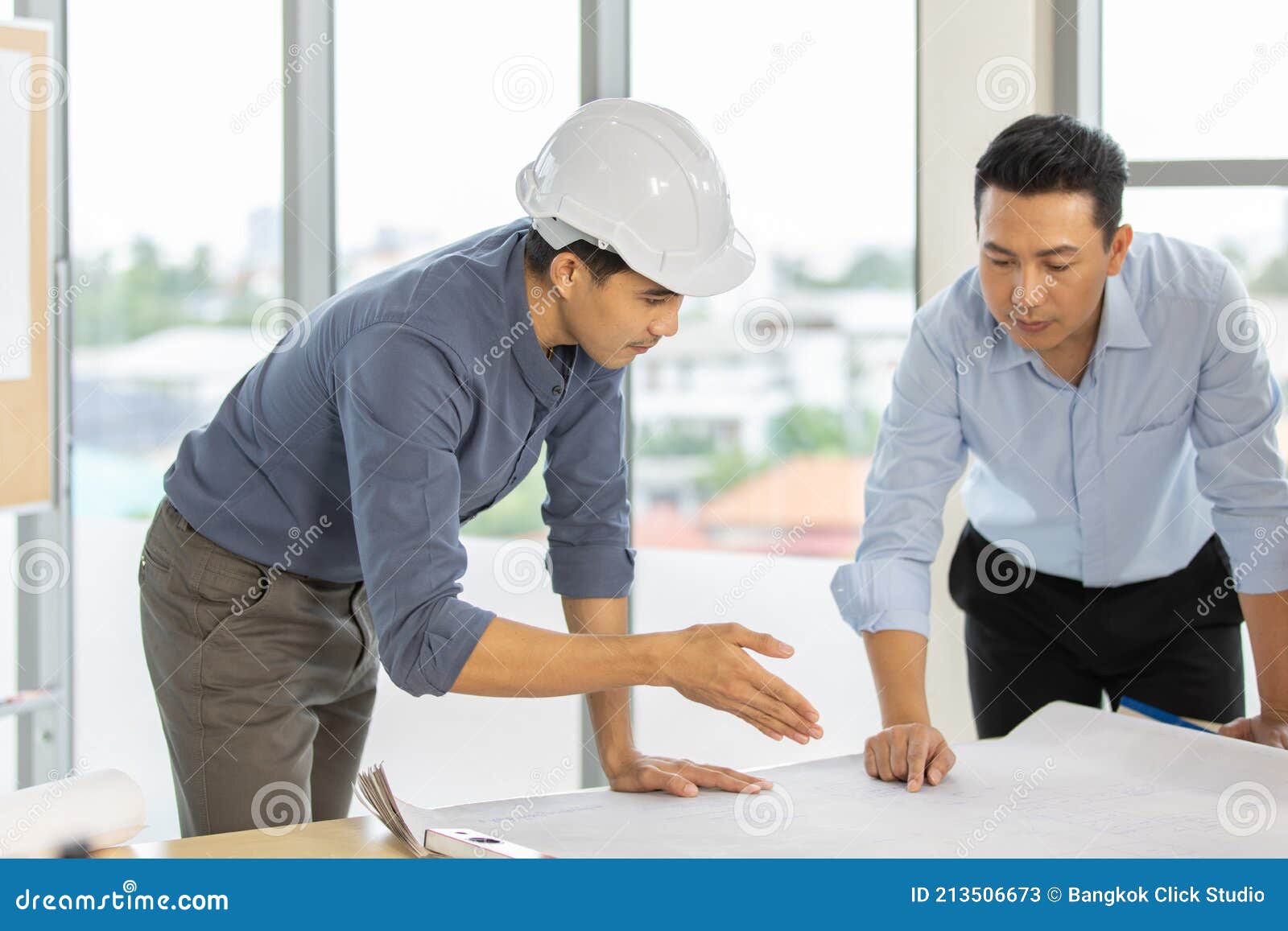 Two Male Engineers Team Talking and Discussing a Home Plan for a ...