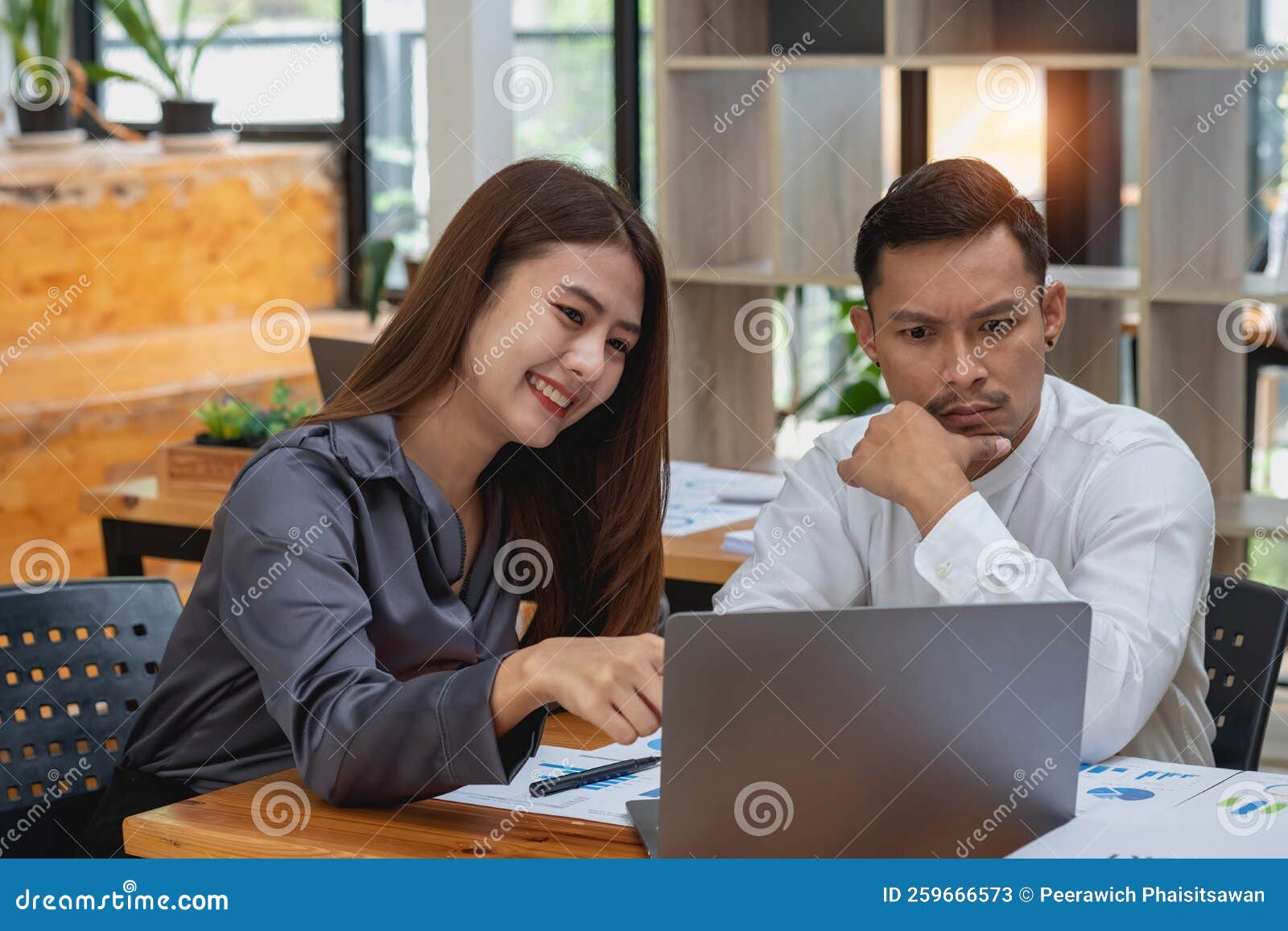 Two Male and Female Marketers Use Company Documents and Use Laptop ...
