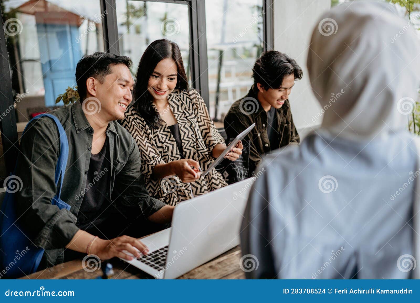 Two Male and Female Students Chat while Working on an Assignment Stock ...