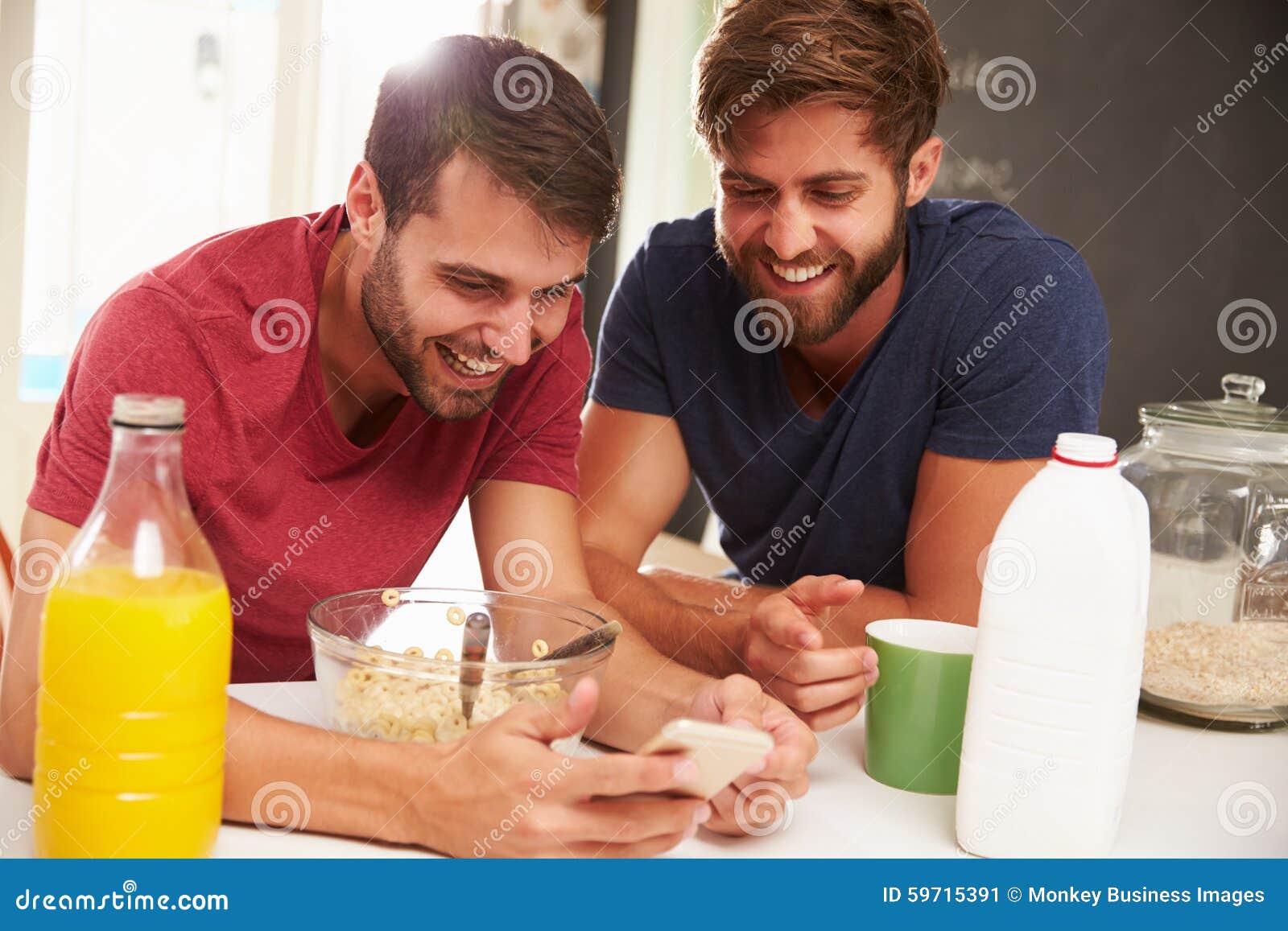 Two Male Friends Having Breakfast and Reading Text Message Stock Image ...