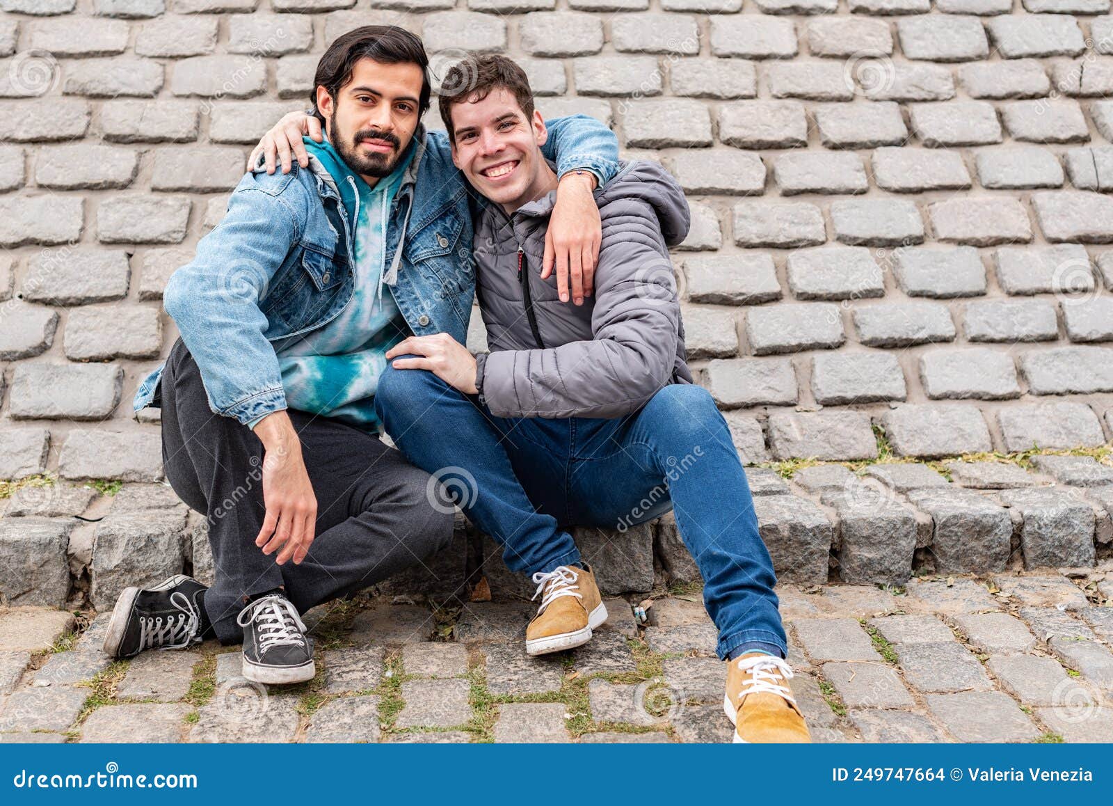 Two Male Friends Hugging and Looking at Camera Outdoors. Copy Space ...