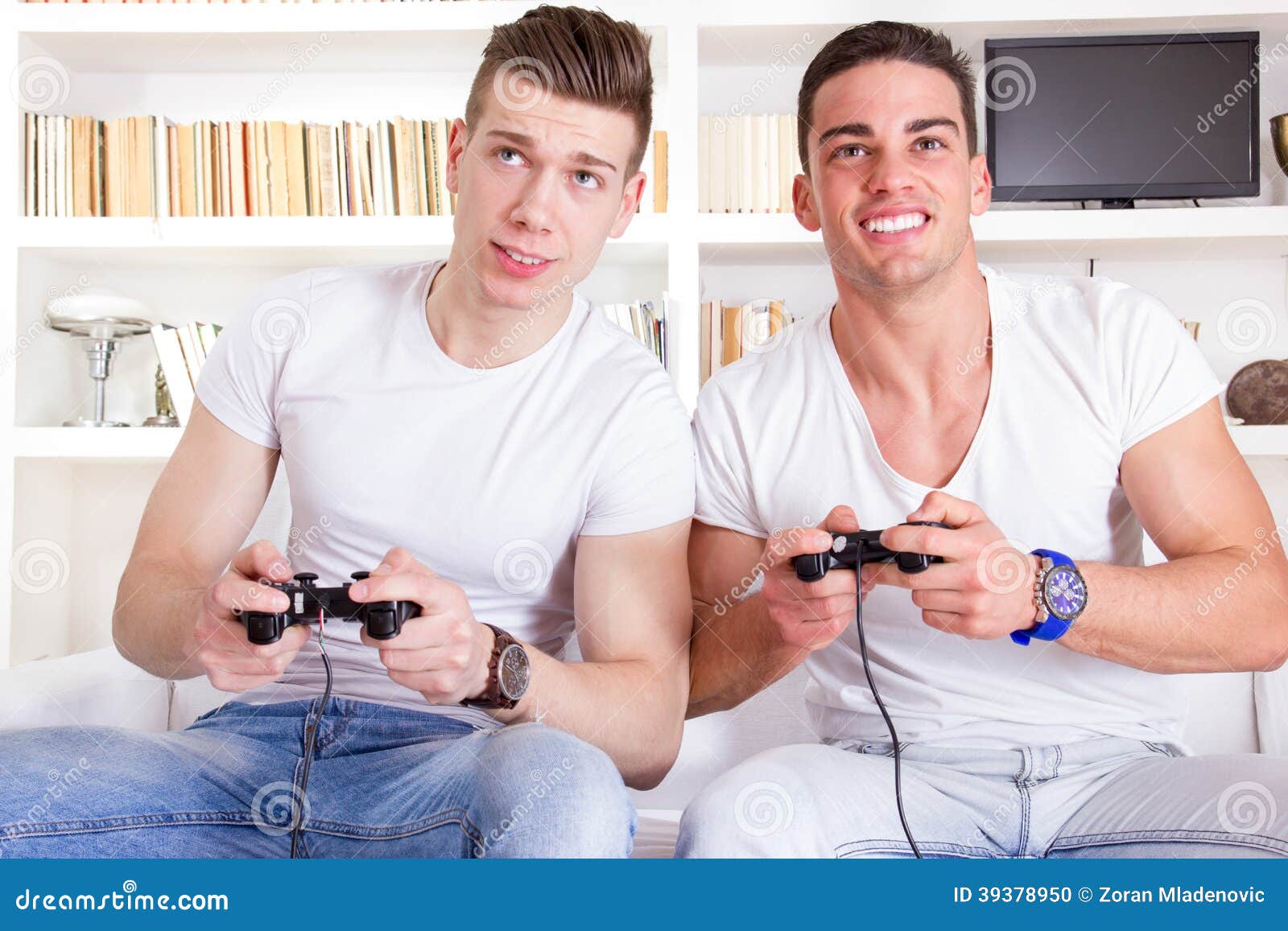 Two Male Friends Playing Video Game with Controllers Stock Photo ...