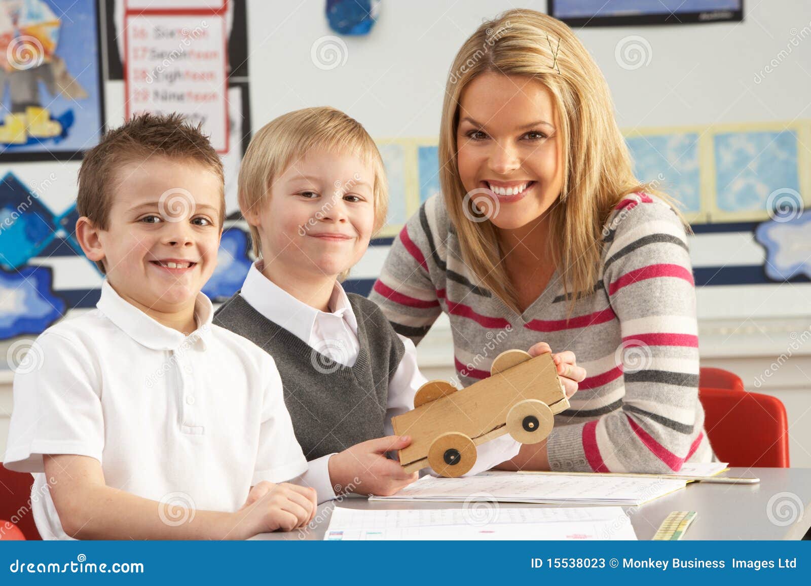 Two Male Primary School Pupils and Teacher Working Stock Image - Image ...