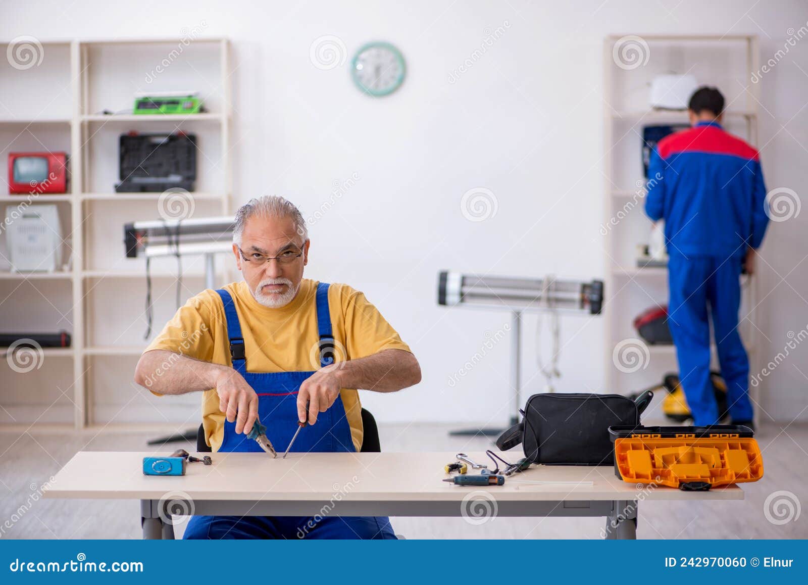 Two Male Repairmen Working at Workshop Stock Photo - Image of worker ...