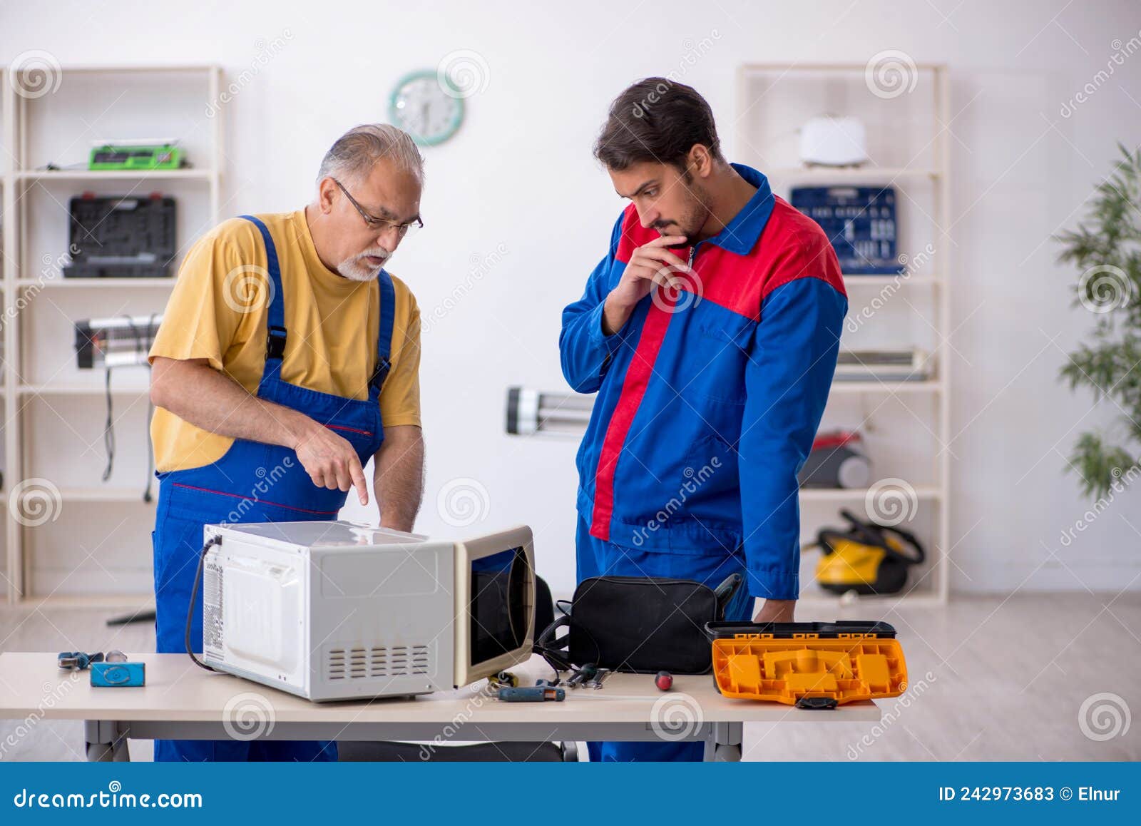 Two Male Repairmen Working at Workshop Stock Image - Image of repairman ...