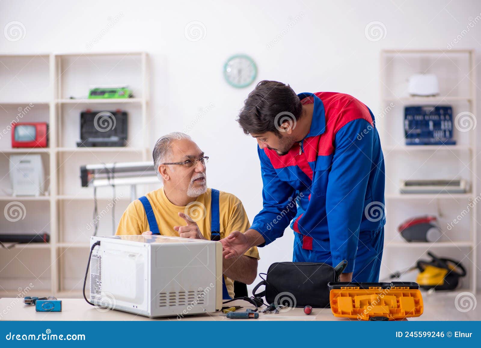Two Male Repairmen Working at Workshop Stock Photo - Image of mechanic ...