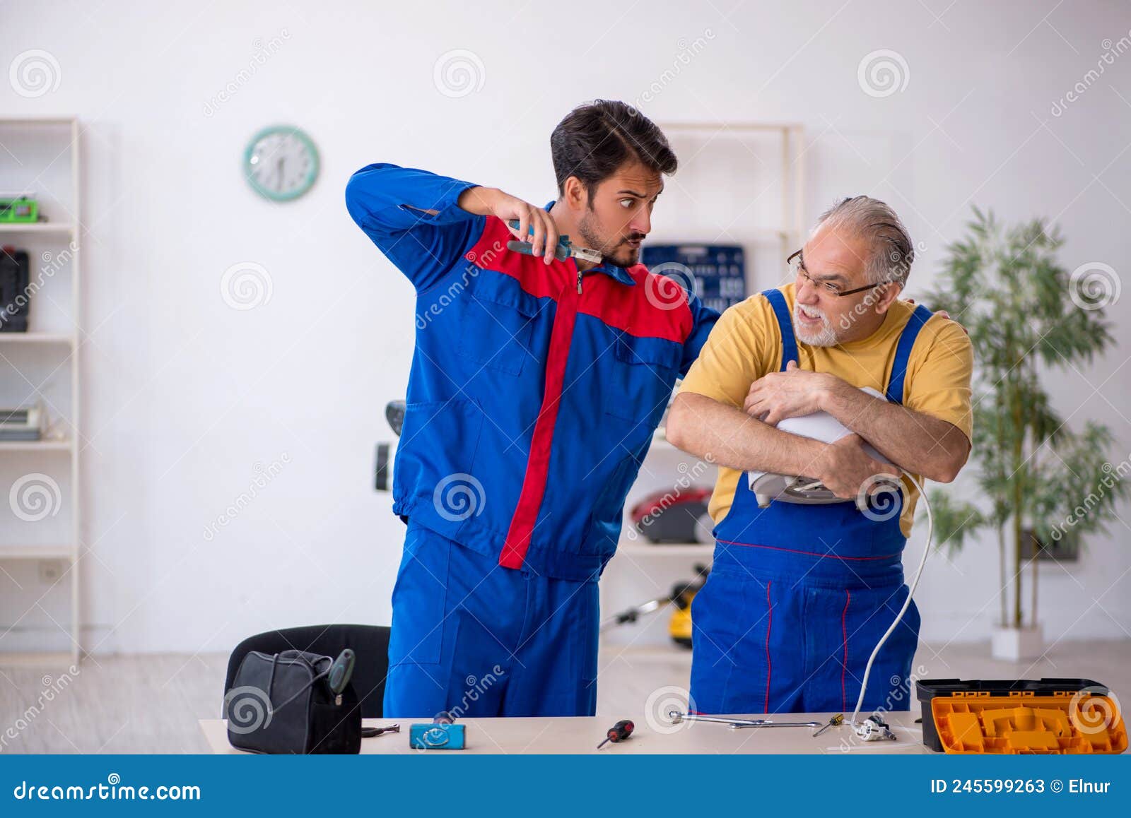 Two Male Repairmen Working at Workshop Stock Image - Image of problem ...
