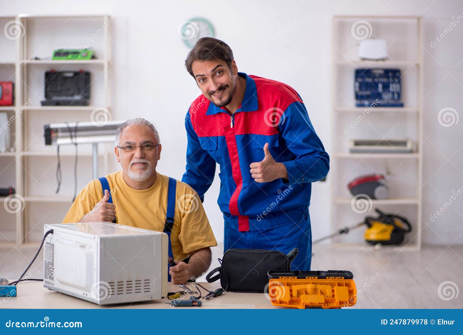Two Male Repairmen Working at Workshop Stock Photo - Image of repairmen ...