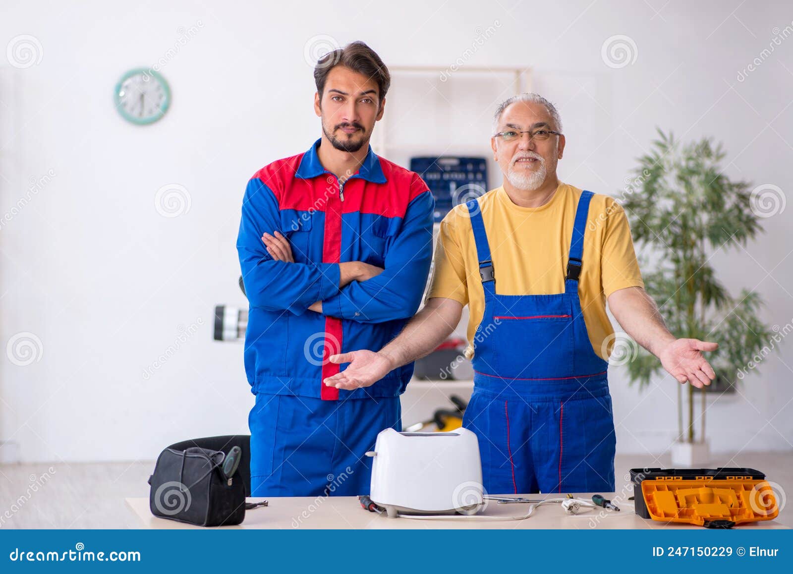 Two Male Repairmen Working at Workshop Stock Image - Image of work ...