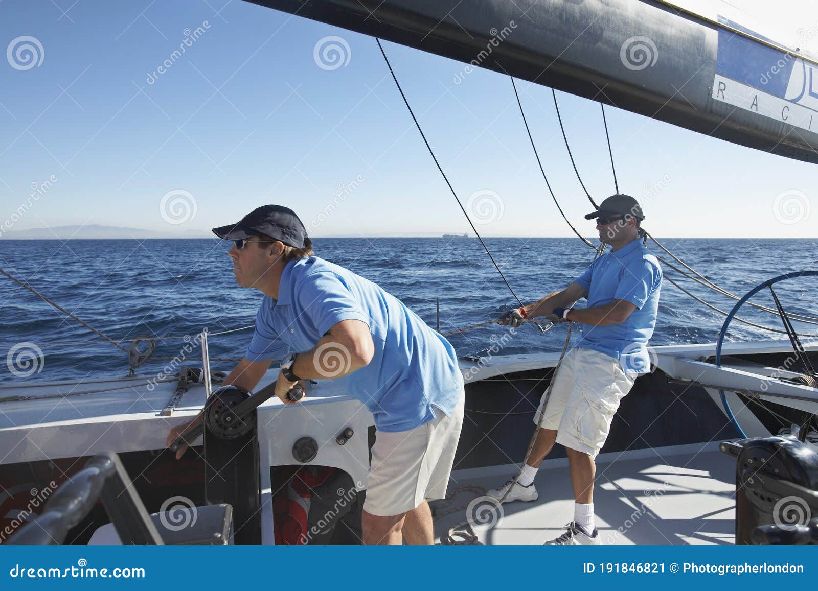 Two male sailors on yacht stock image. Image of ocean - 191846821