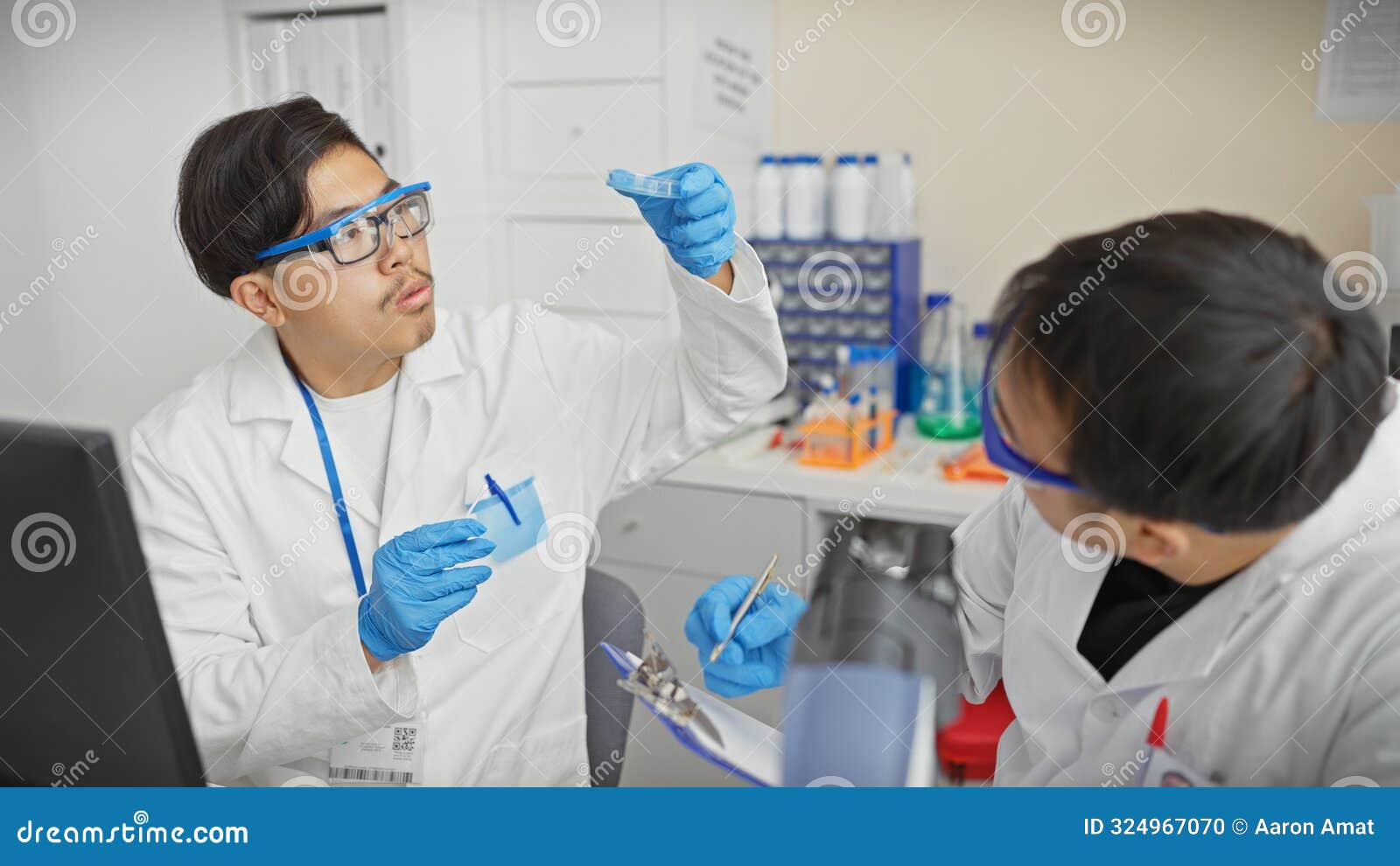 Two Male Scientists Working Together in a Laboratory, Examining Samples ...
