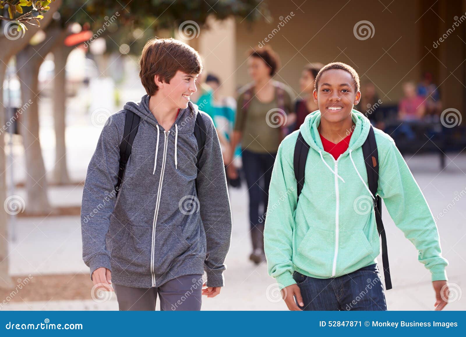 Two Male Students Walking To High School Stock Image - Image of ...