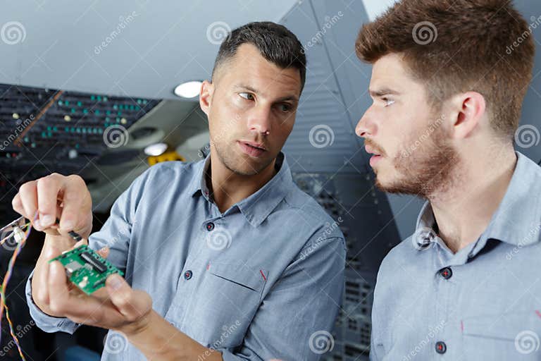 Two Male Technicians Looking at Electronic Chip Stock Image - Image of ...