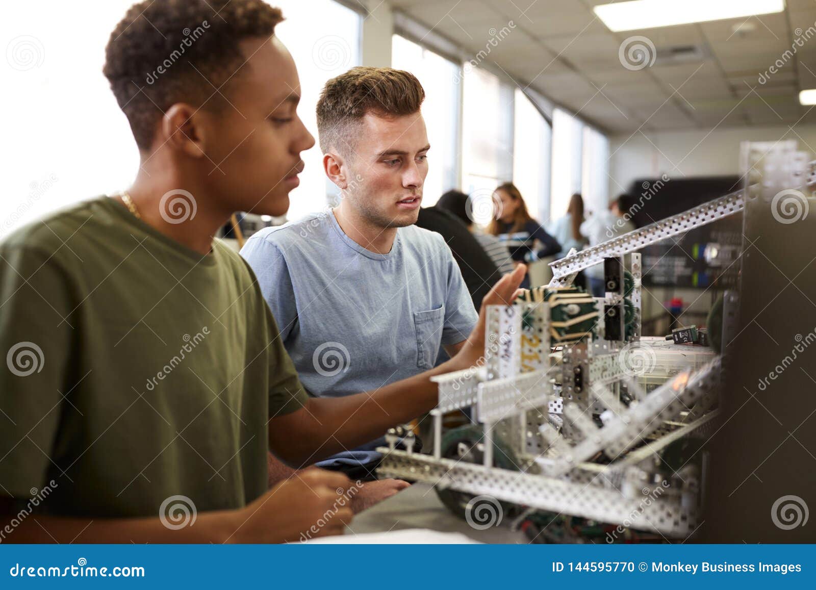 Two Male University Students Building Machine in Science Robotics or ...