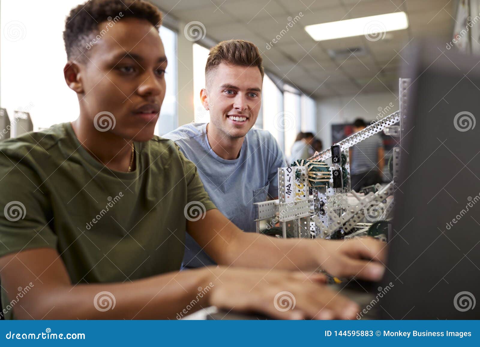Two Male University Students Building Machine in Science Robotics or ...