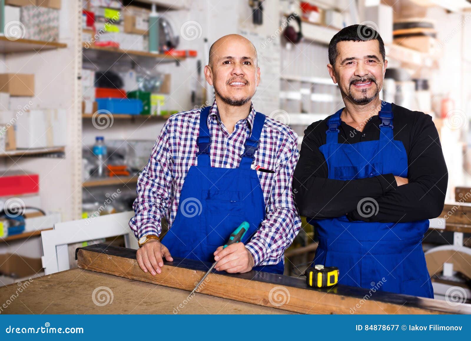 Two Male Woodworkers Posing at Workplace in Workshop and Smiling Stock ...