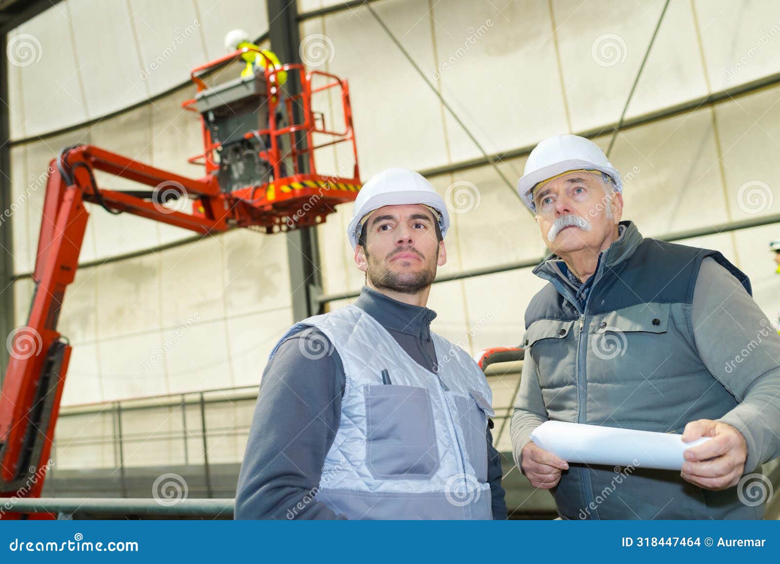 Two Male Workers with Cherry Picker in Background Stock Photo - Image ...
