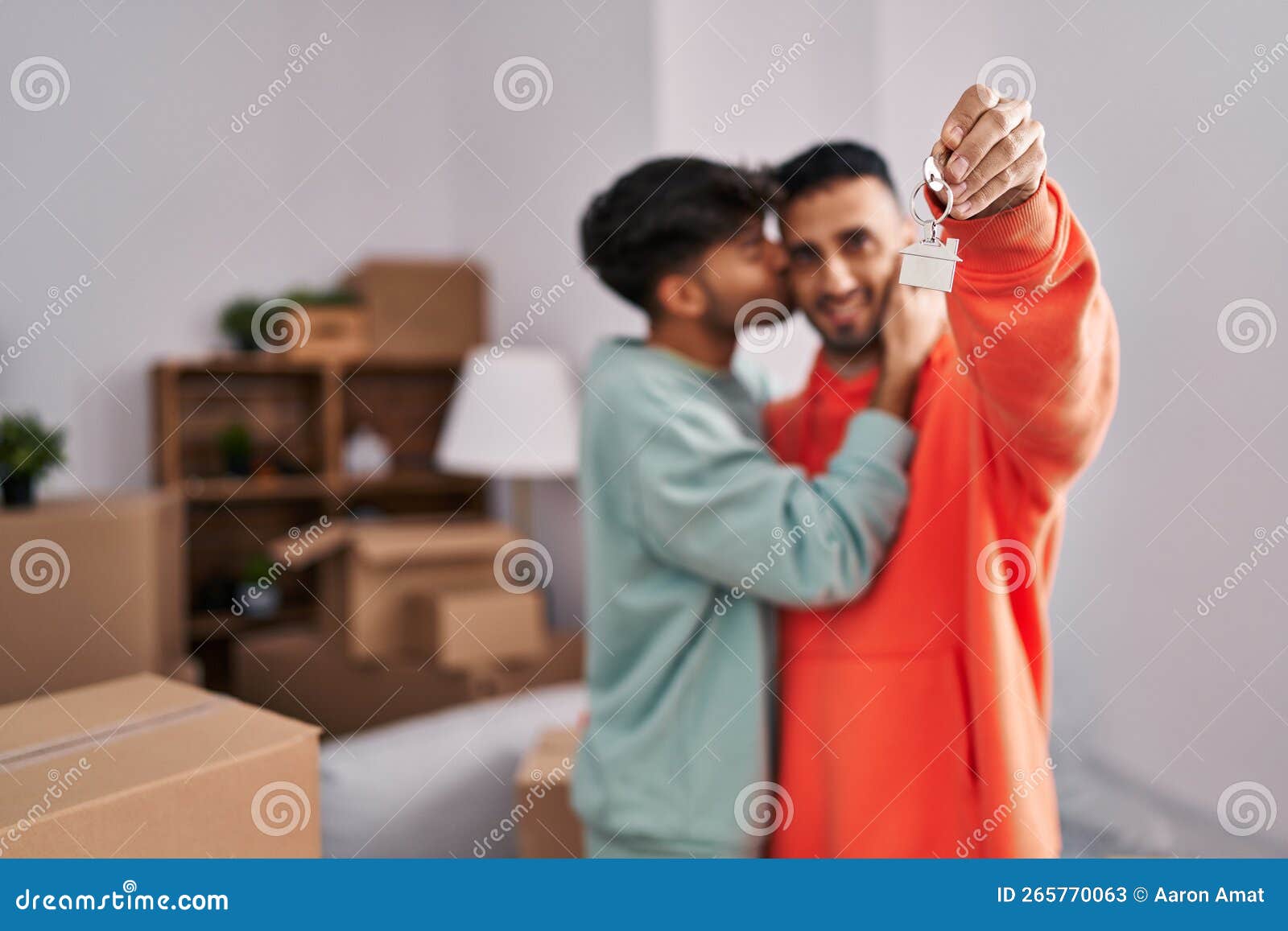 Two Man Couple Hugging Each Other Holding Key At New Home Stock Image