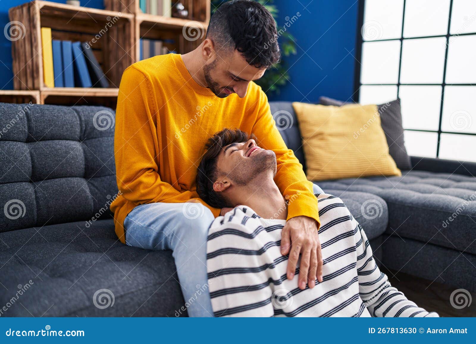 Two Man Couple Hugging Each Other Sitting on Sofa at Home Stock Photo ...