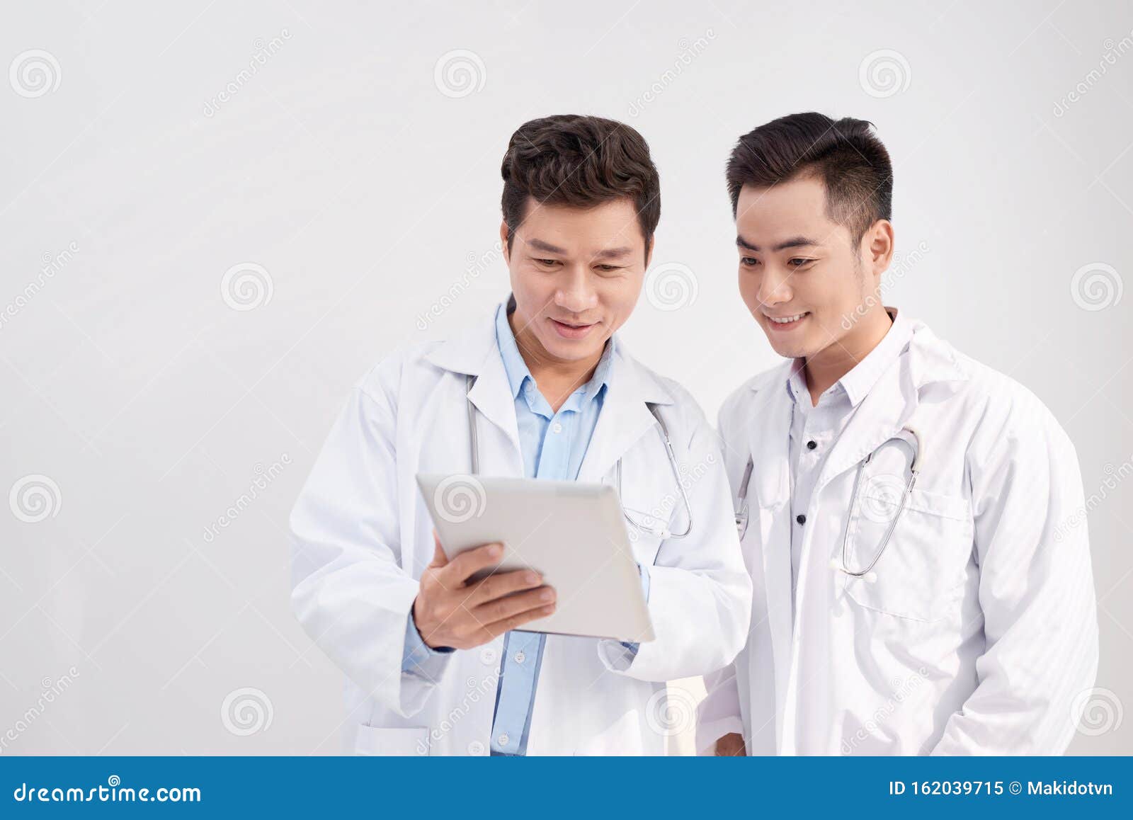 Two Man Doctor Looking at the Ipad/tablet and Having a Discussion Stock ...