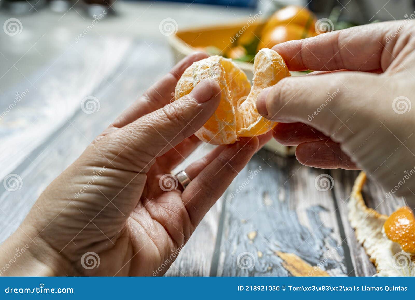 Two Man S Hands Separating a Segment of Ripe Tangerine and in the ...