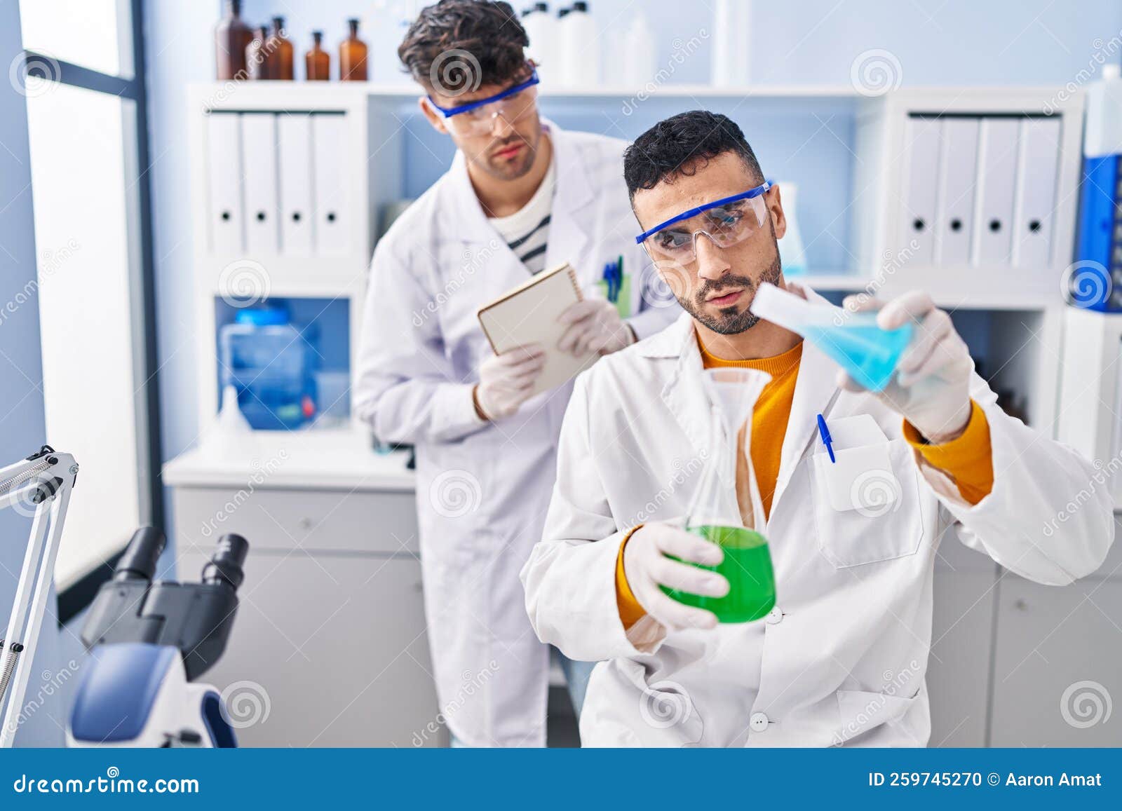 Two Man Scientists Measuring Liquid at Laboratory Stock Photo - Image ...