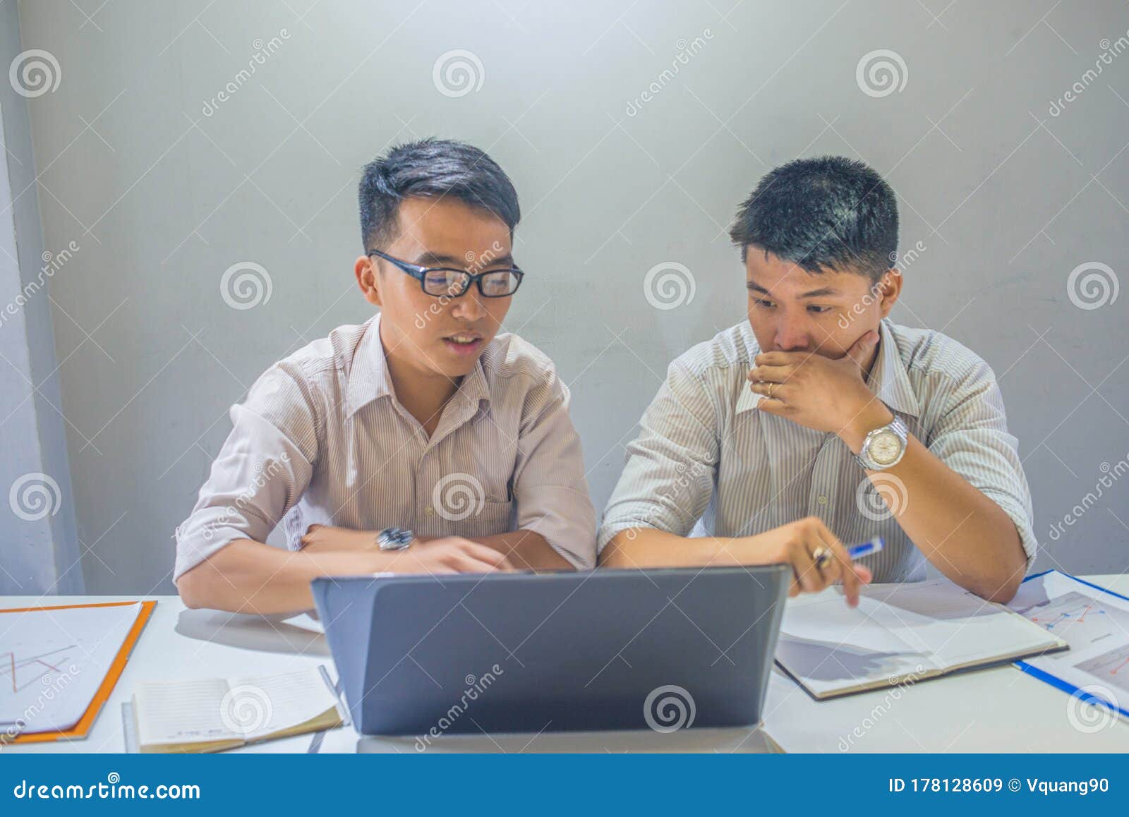 Two Man Using Laptop and Having Discussion at Business Workplace Stock ...